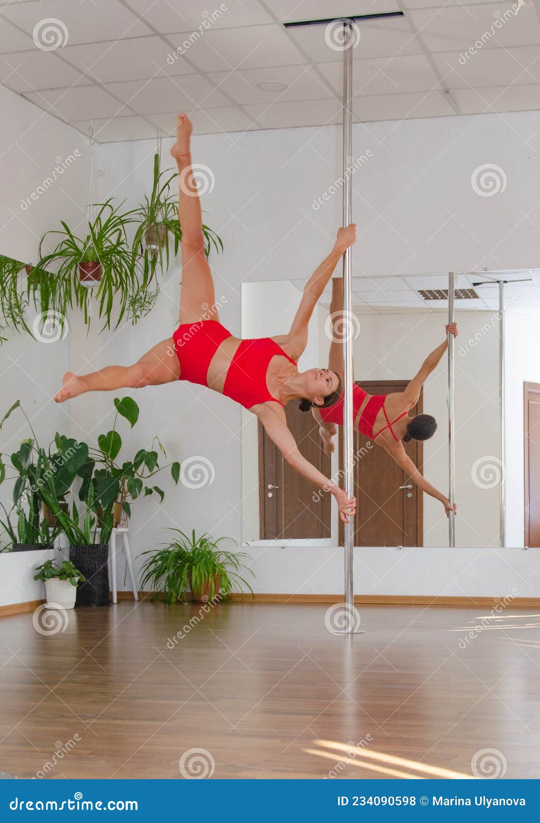 A Girl Dances on a Pole and Performs Acrobatic Stock Photo - Image of girl, striptease: 234090598