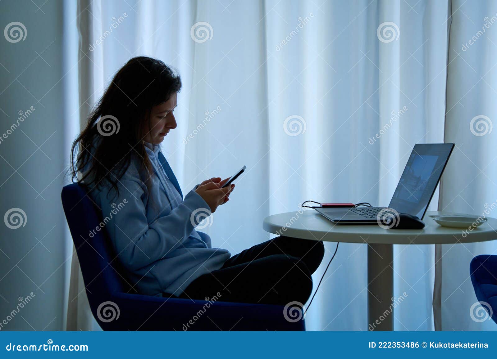 The Girl is Distracted by the Phone at the Workplace at the Computer ...