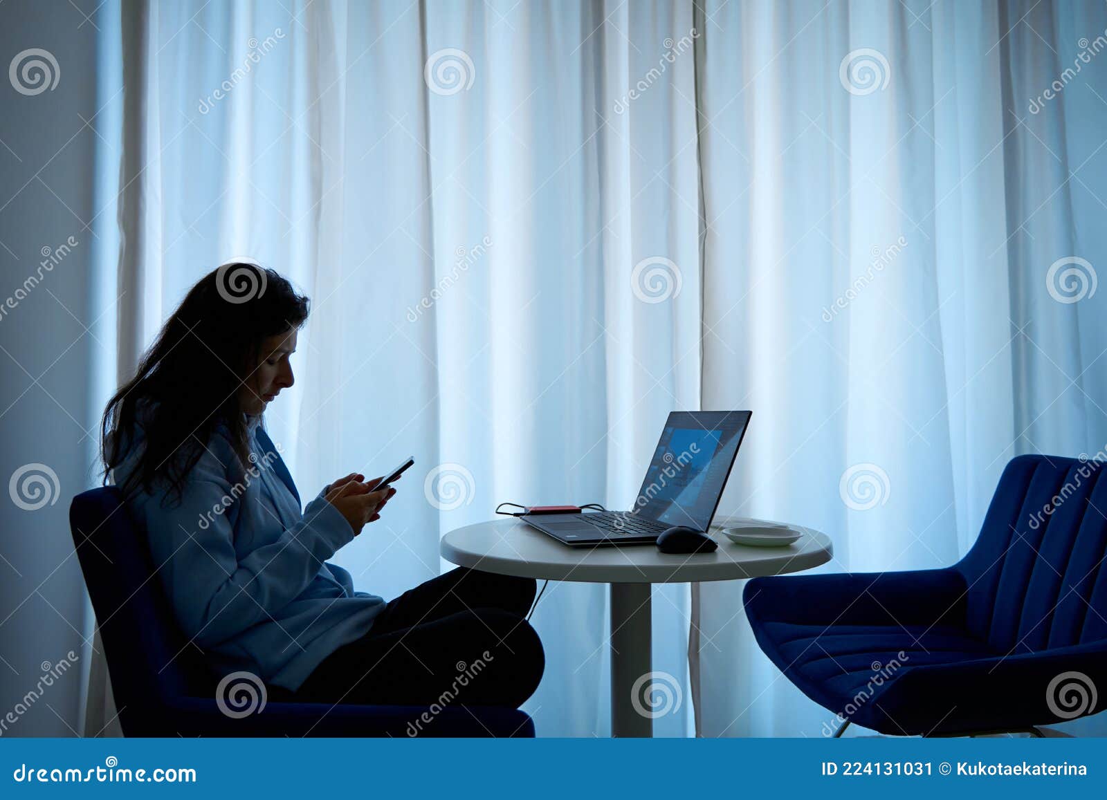 The Girl is Distracted by the Phone at the Workplace at the Computer ...