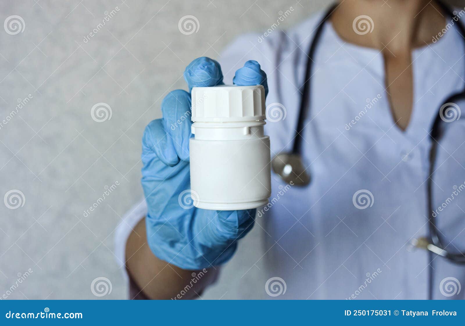 Girl Doctor In A White Coat Holds A Package Of Pills In Her Hand
