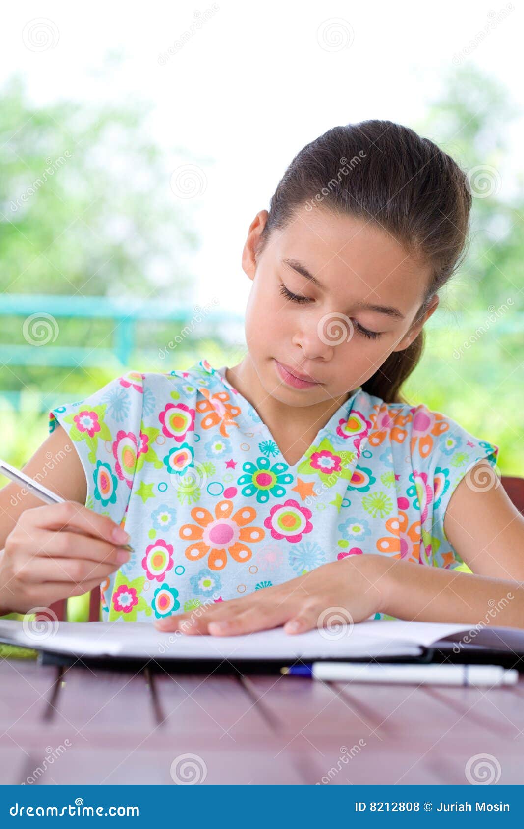 Girl doing her homework. stock photo. Image of notebook - 8212808