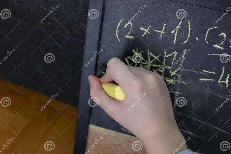 Girl Doing Math with Chalk on Blackboard. Stock Photo - Image of ...