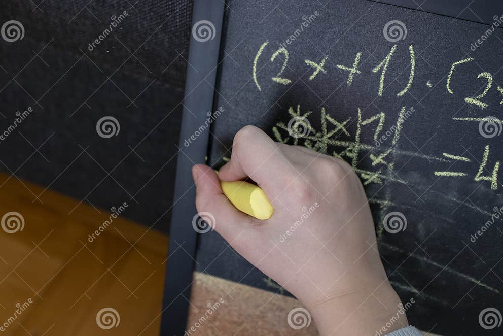 Girl Doing Math with Chalk on Blackboard. Stock Photo - Image of ...