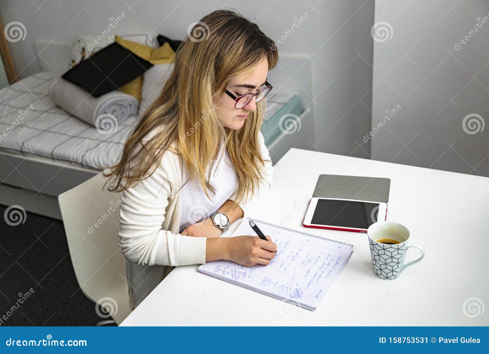 Girl Doing Notes on Paper Sitting at Table in Room Stock Image - Image ...