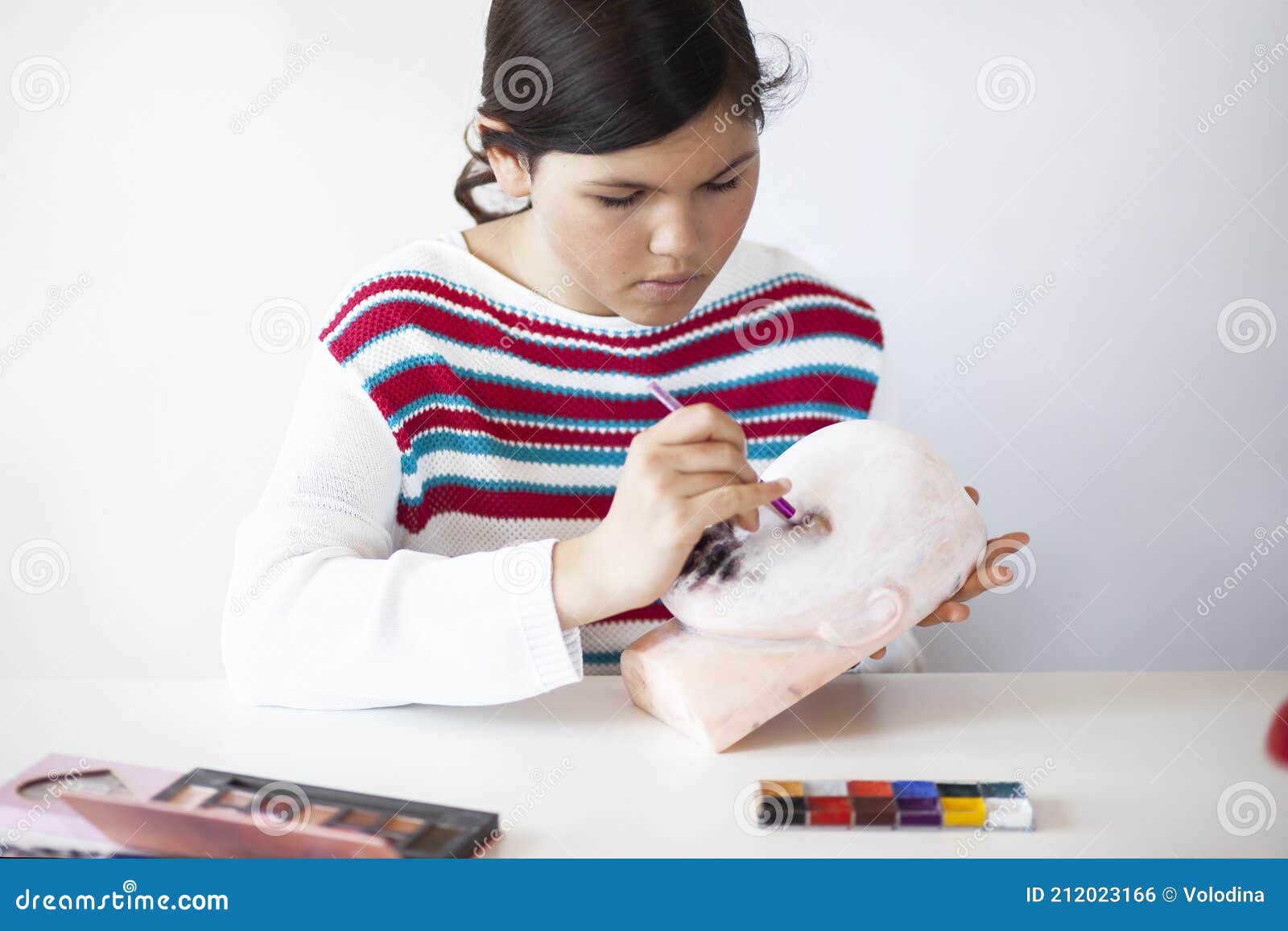 Girl Doing SFX Makeup on a Training Rubber Head for Makeup Stock Photo ...