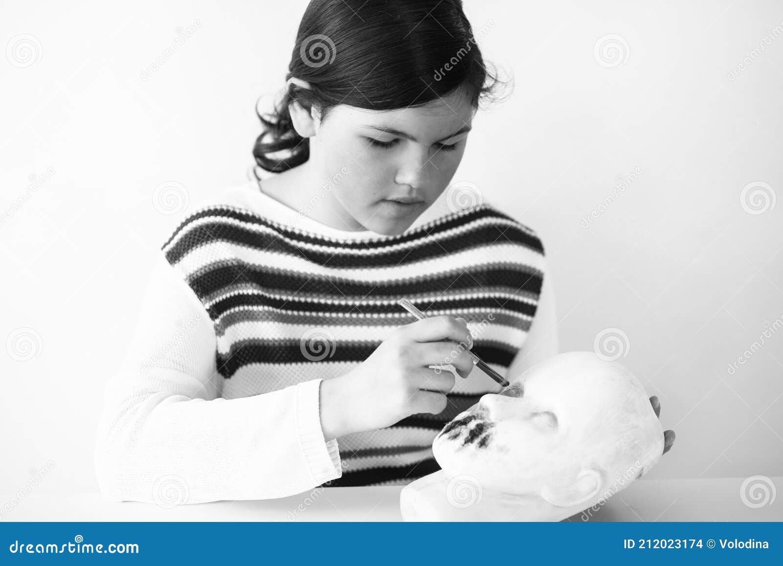 Girl Doing SFX Makeup on a Training Rubber Head for Makeup Stock Photo ...