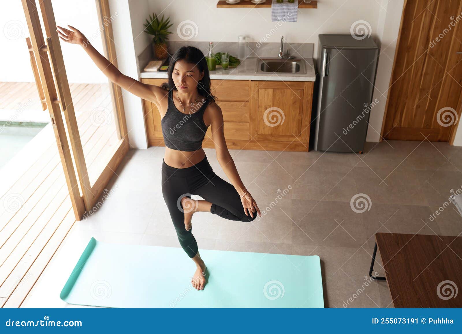 Girl Doing Yoga Training At Home Beautiful Woman Standing At One Leg
