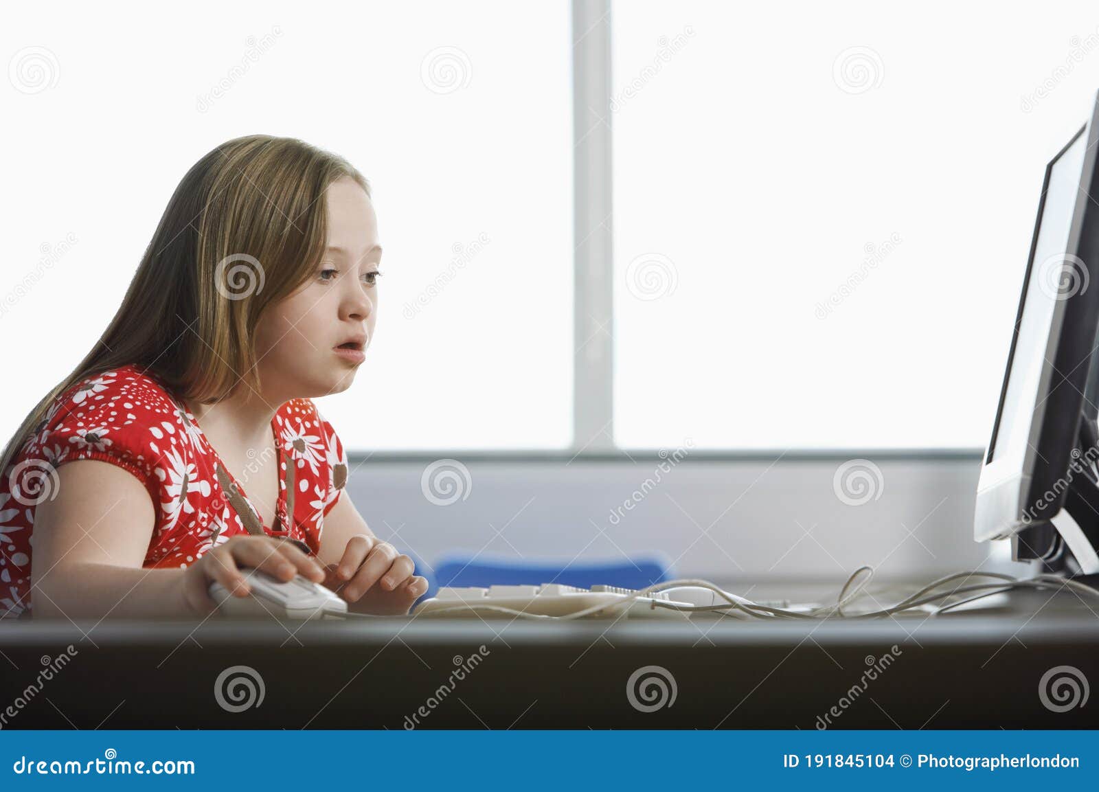 Girl (10-12) with Down Syndrome Using Computer in Computer Lab Stock ...