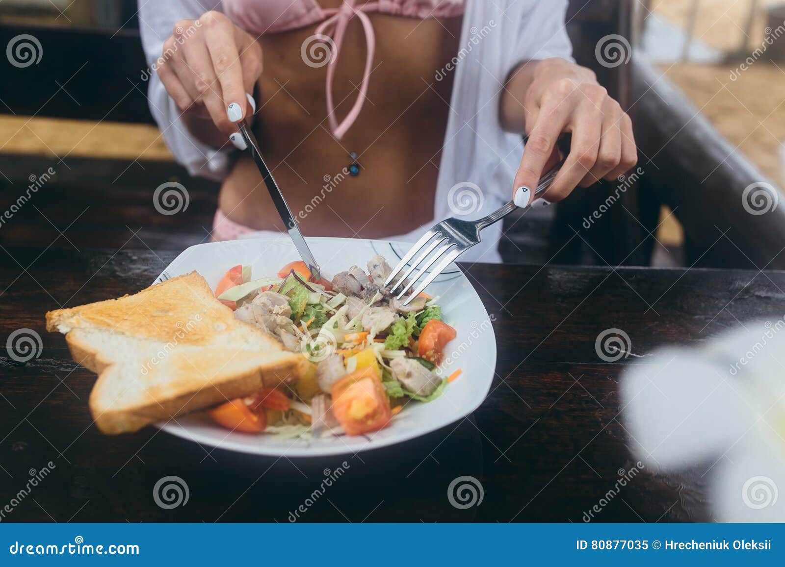 Girl eating on the beach stock image. Image of sensual - 80877035