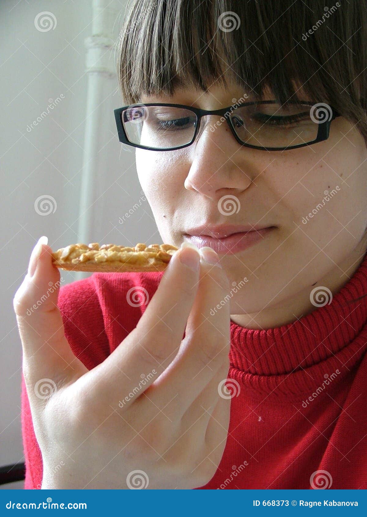 Girl Eating Biscuit stock image. Image of spectacles, glasses - 668373