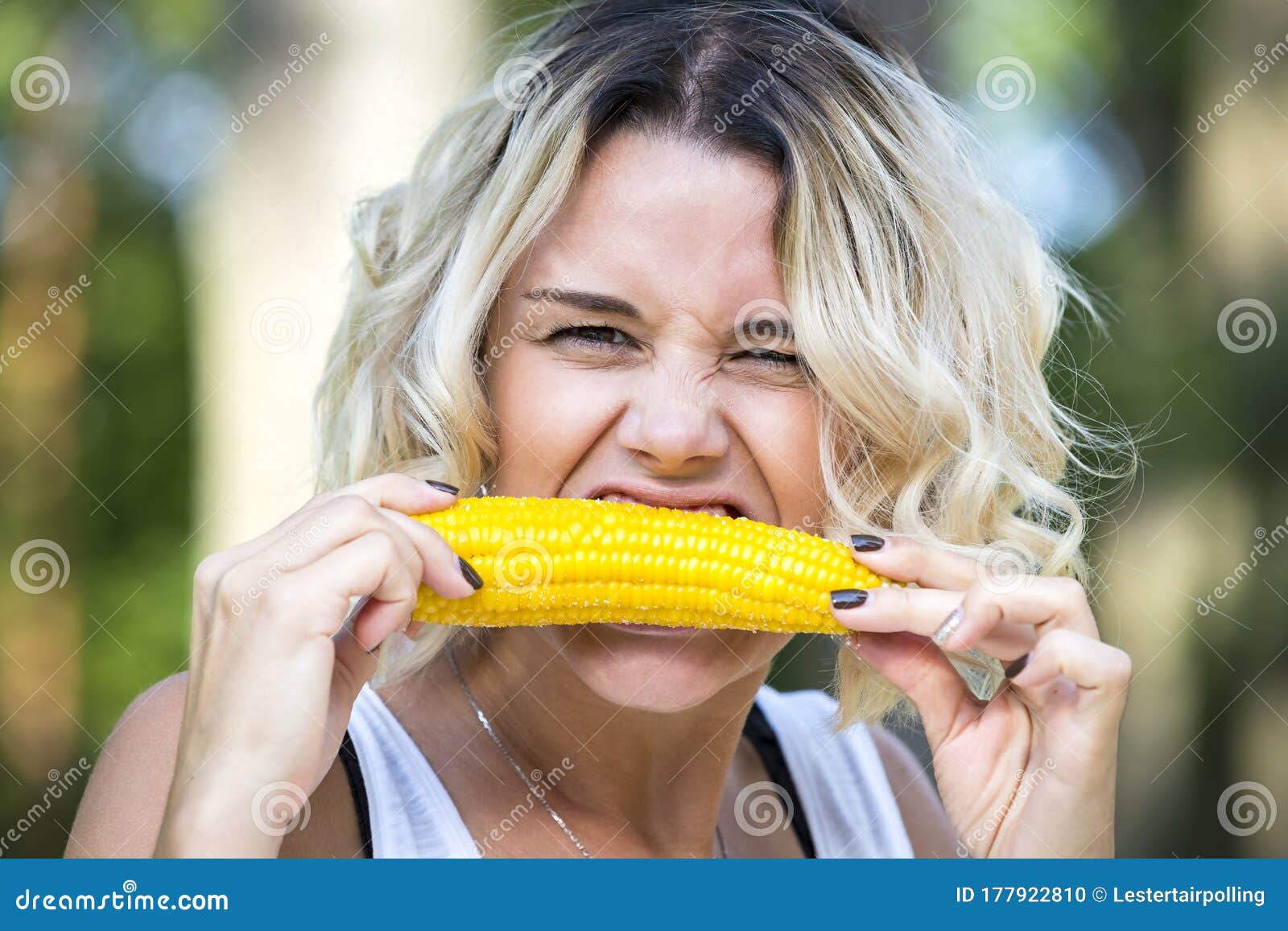 The Girl is Eating Boiled Sweet Corn Stock Photo - Image of face ...