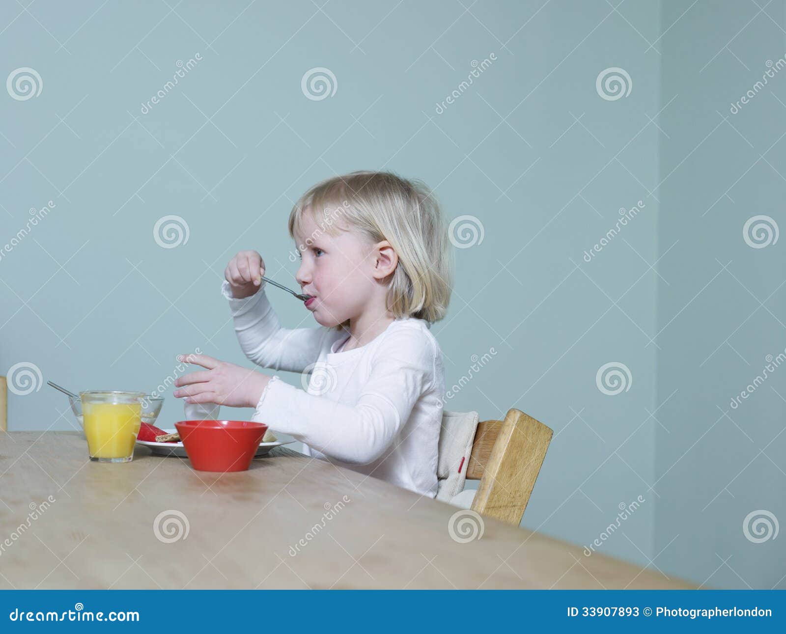 Girl Eating Breakfast at Dining Table Stock Image - Image of domestic ...