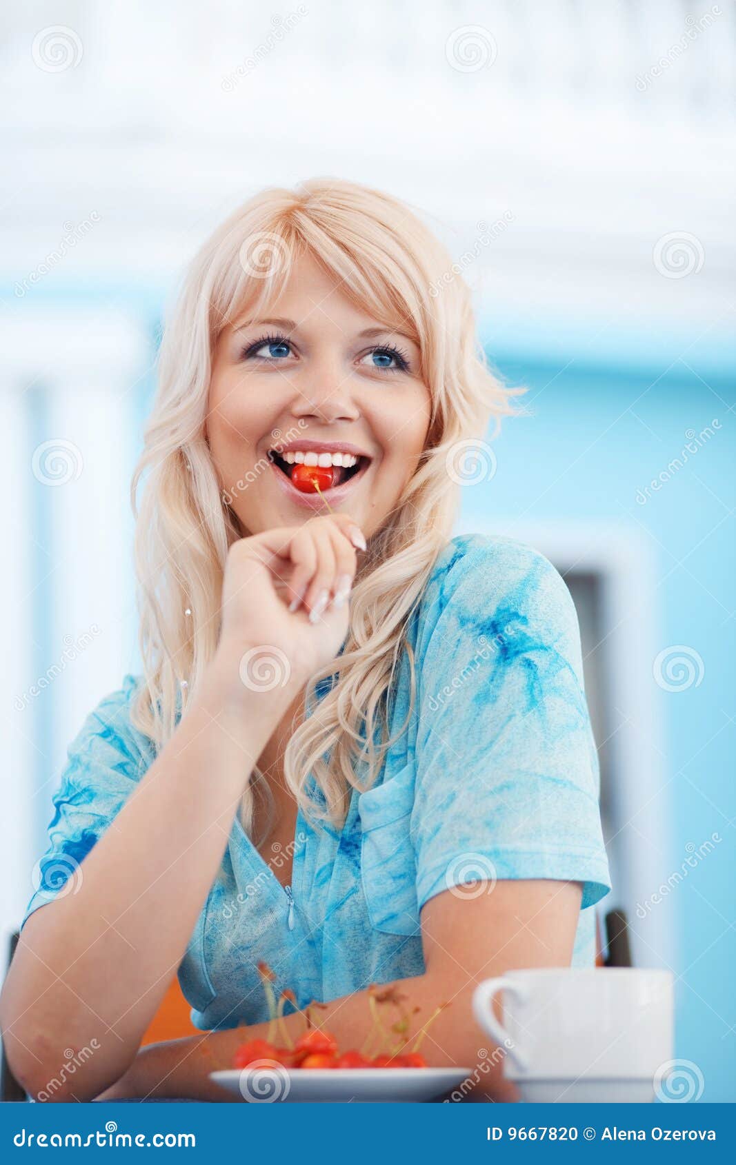 Girl eating cherry in cafe stock photo. Image of eyes - 9667820