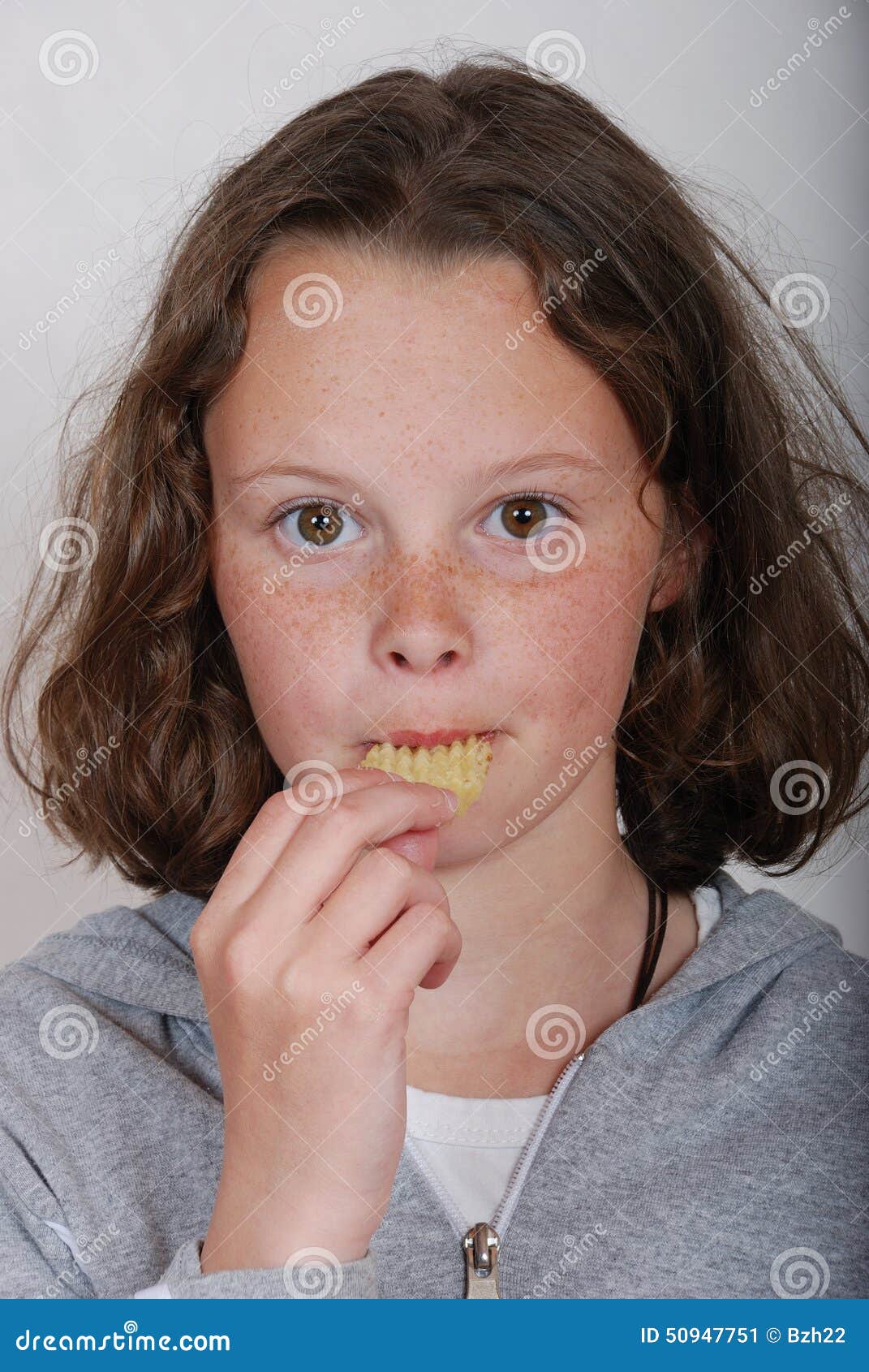 Girl eating chip stock image. Image of joyful, female - 50947751