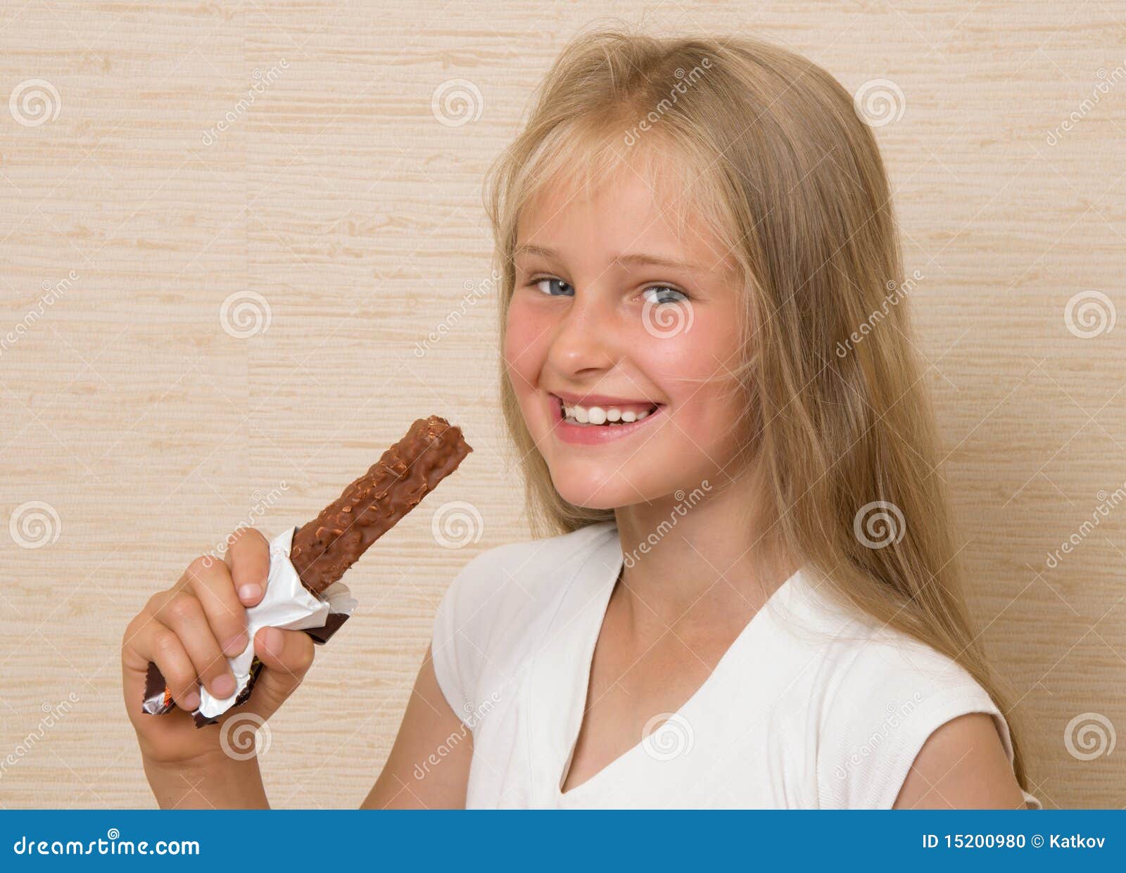 Girl eating chocolate bar stock photo. Image of female - 15200980