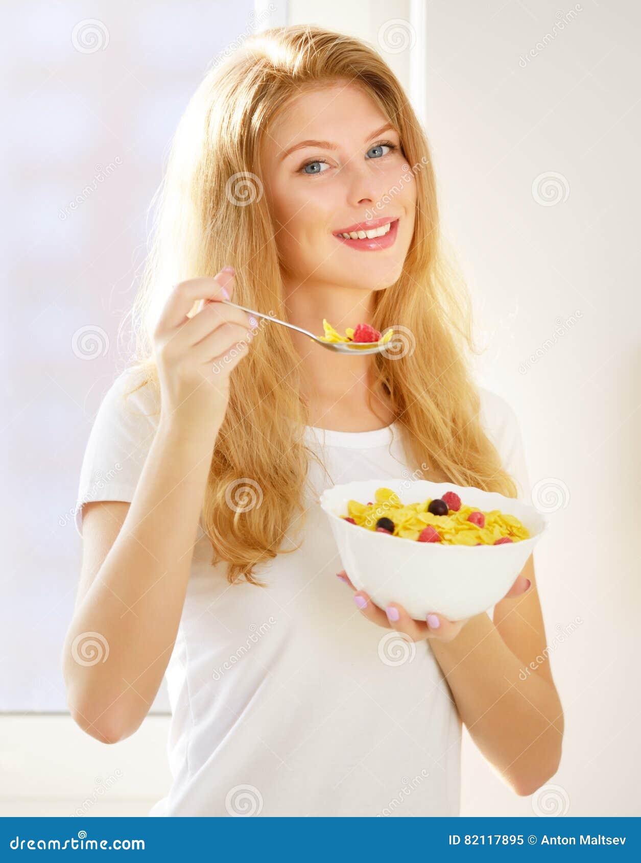 Girl eating corn flakes stock image. Image of flakes - 82117895