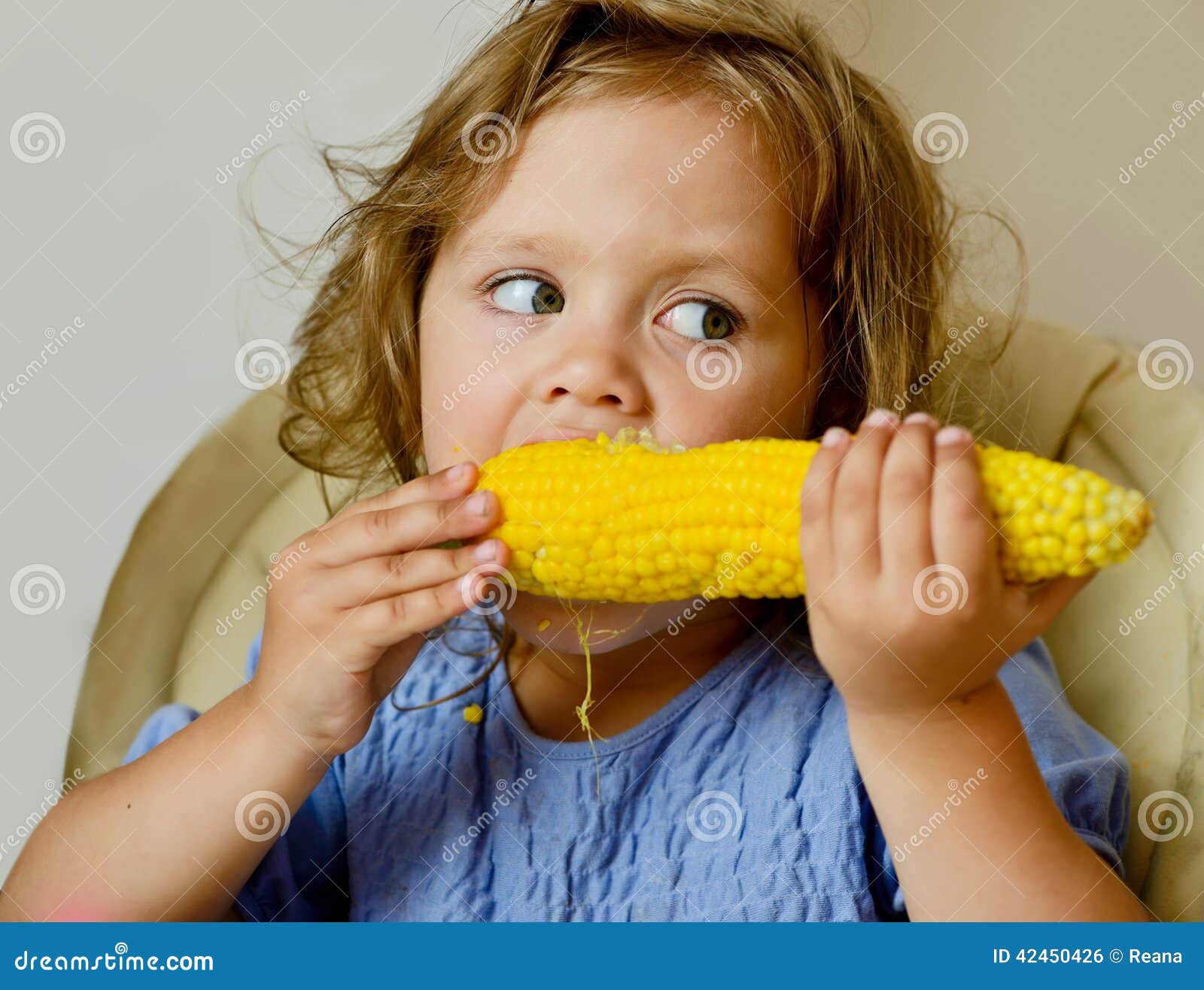 Girl eating corn stock photo. Image of food, chair, cuisine - 42450426
