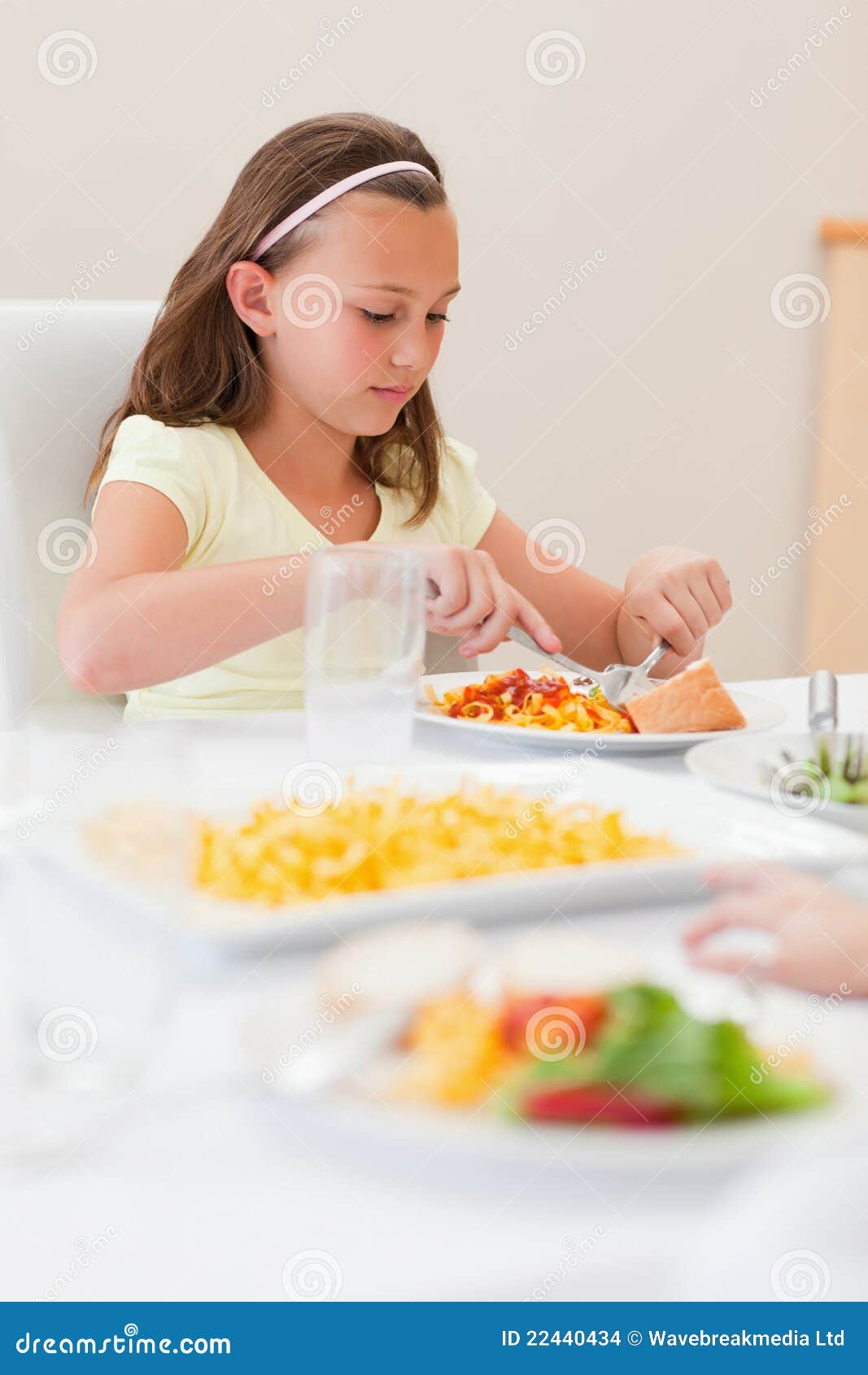 Girl Eating at Dinner Table Stock Photo - Image of diet, dish: 22440434