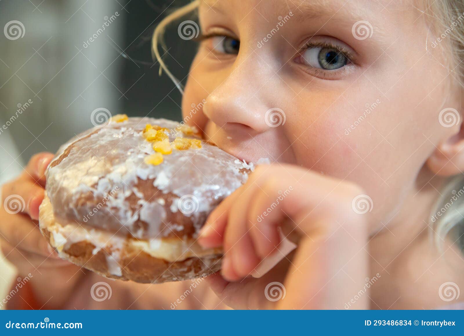 The girl is eating a donut stock photo. Image of children - 293486834