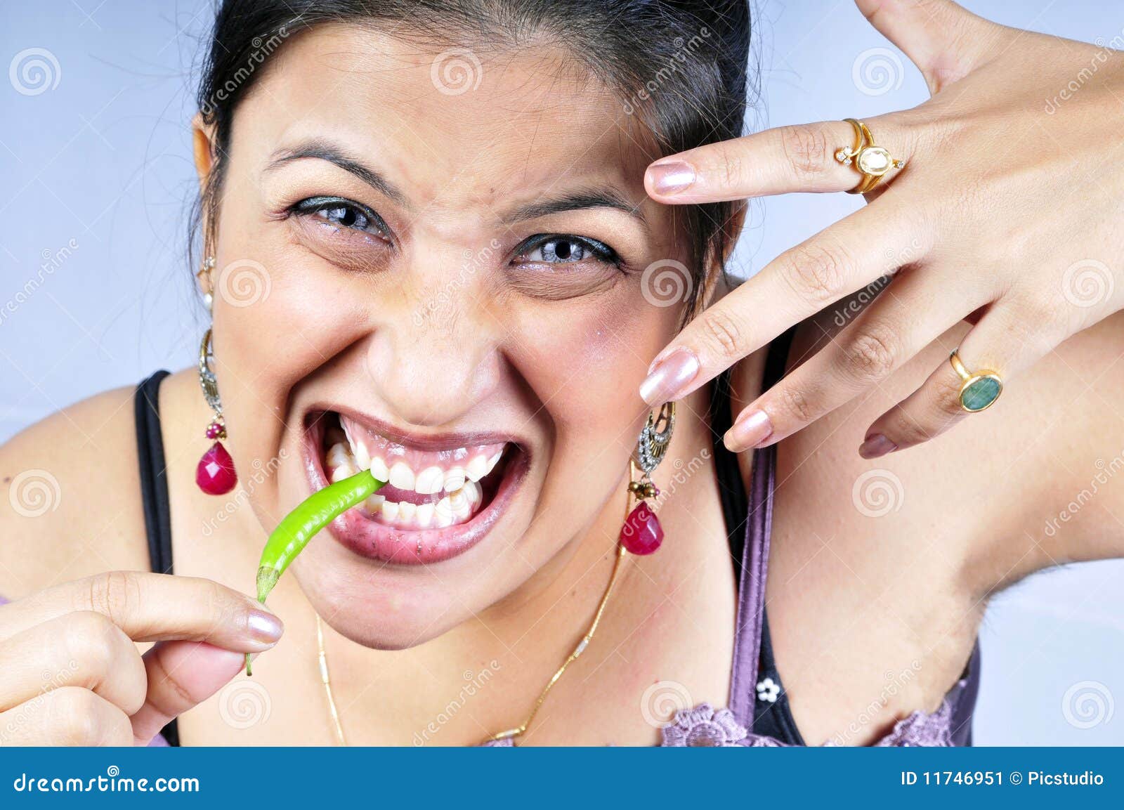 Girl eating green chilly stock image. Image of eyes, colour - 11746951