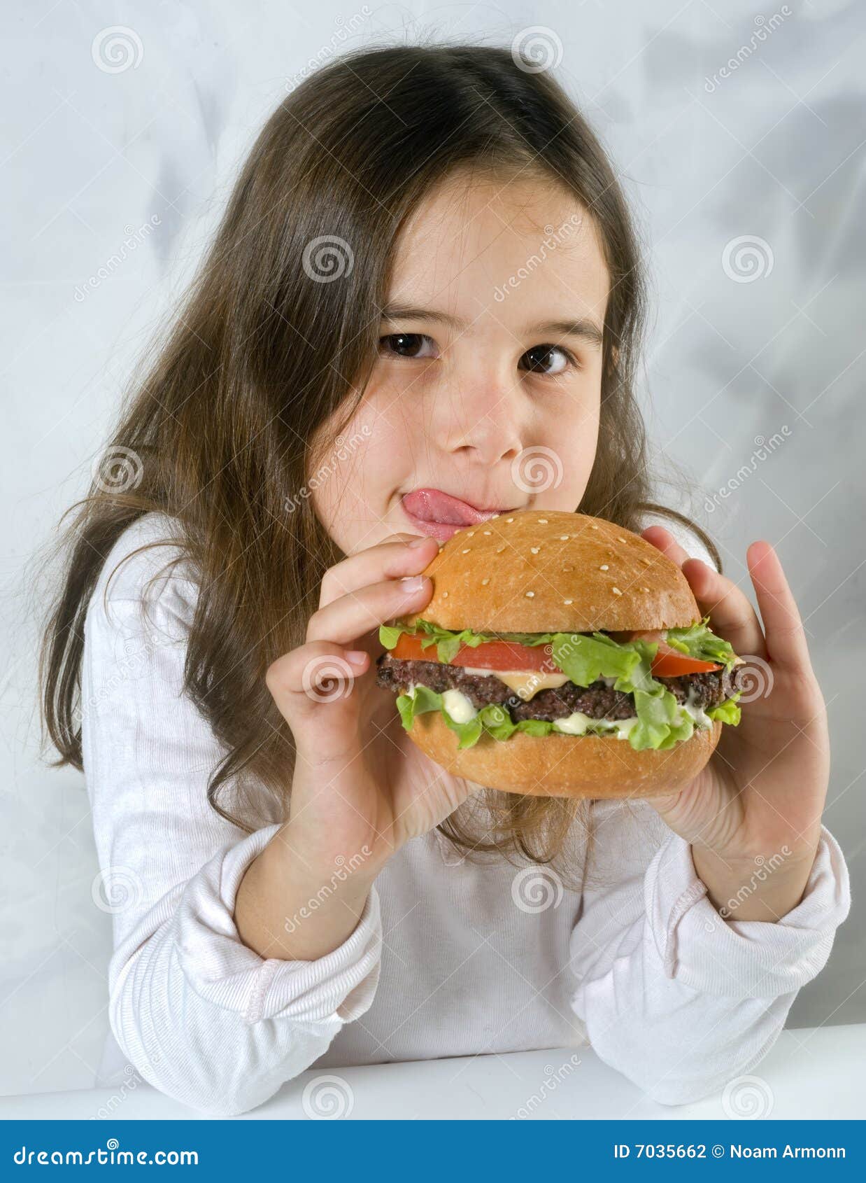 Girl eating hamburger stock photo. Image of meal, female - 7035662