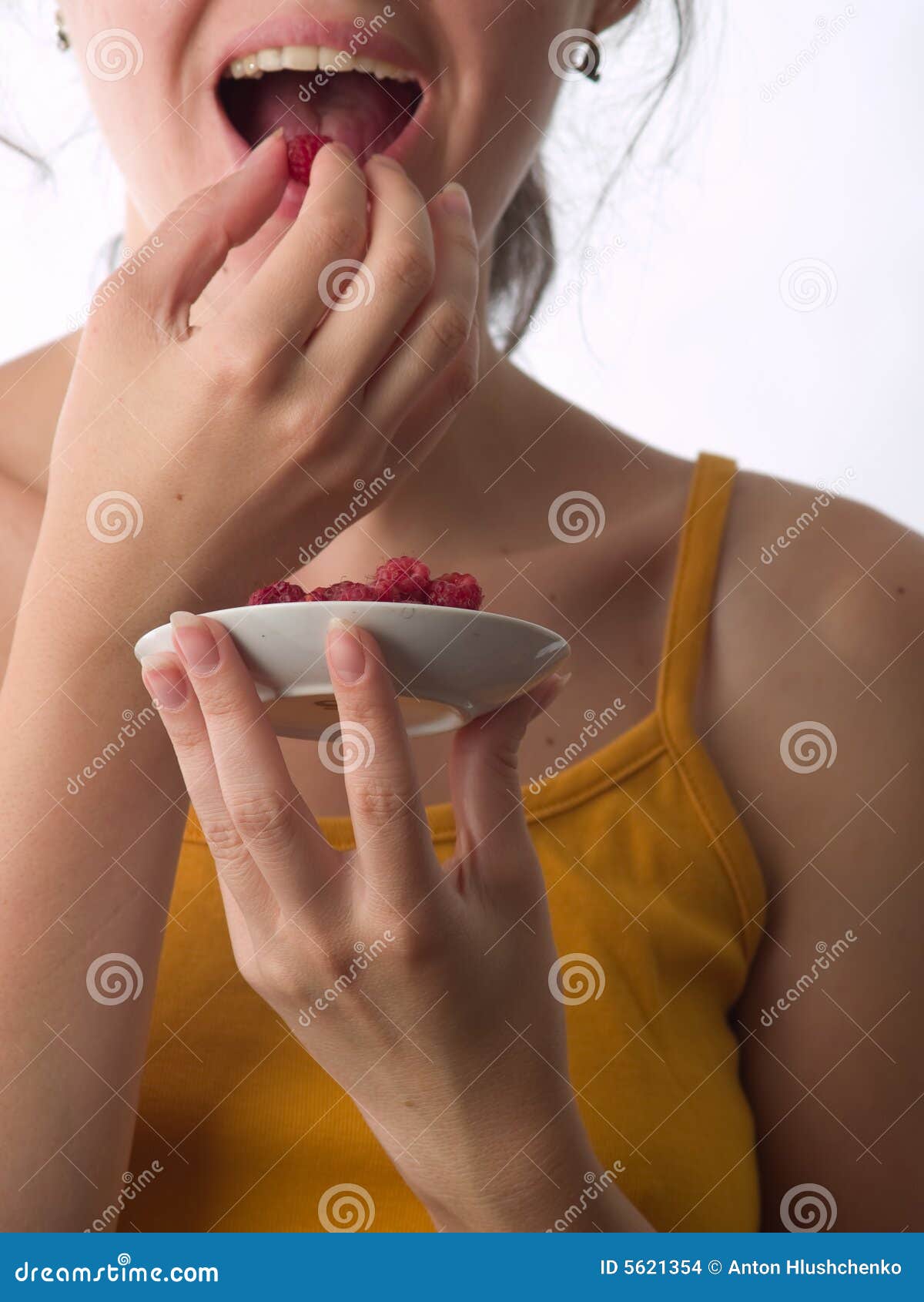 Girl eating raspberry stock photo. Image of freshness - 5621354