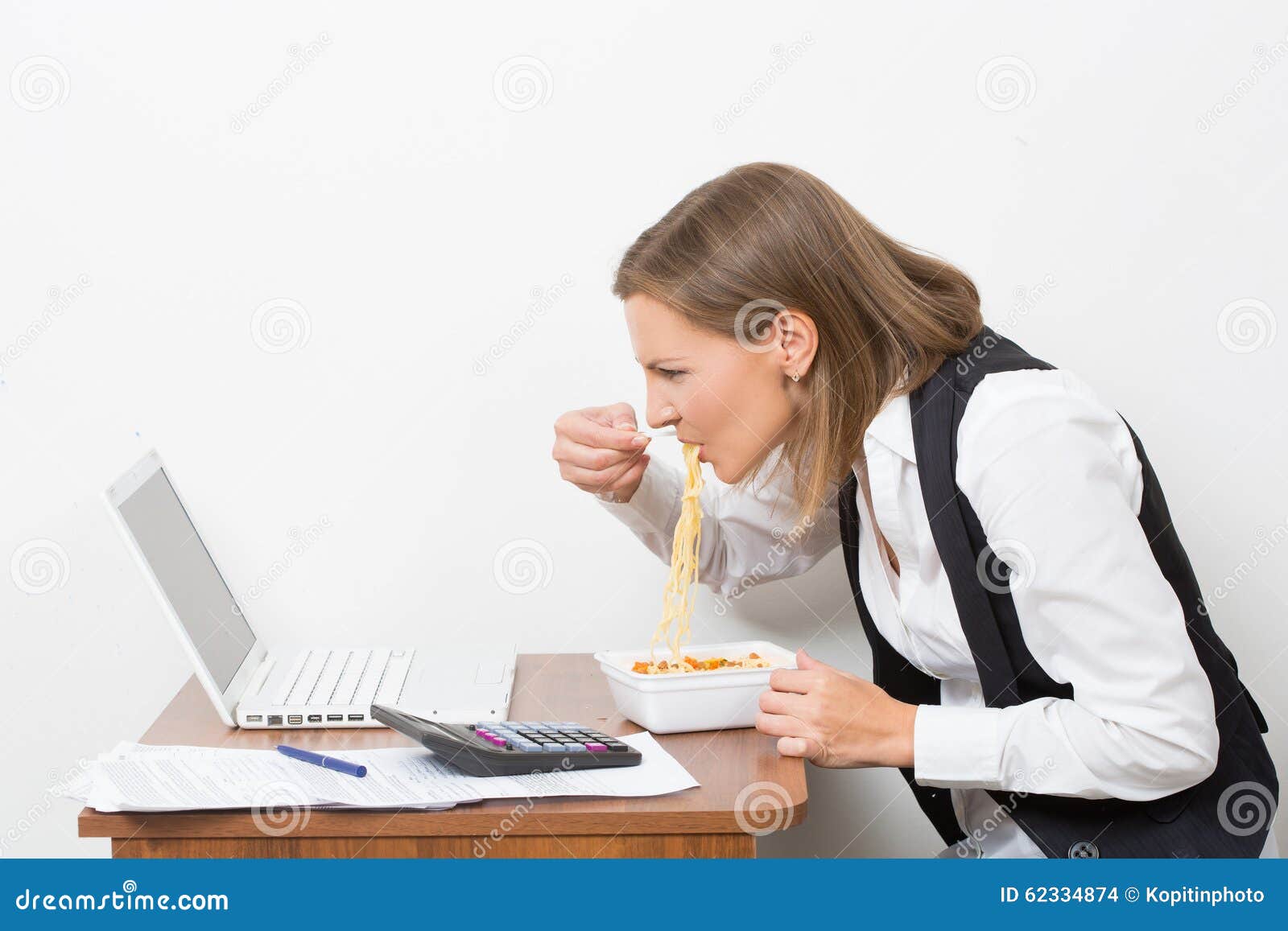 Girl Eats a Pasta, Working Behind the Laptop Stock Photo - Image of ...