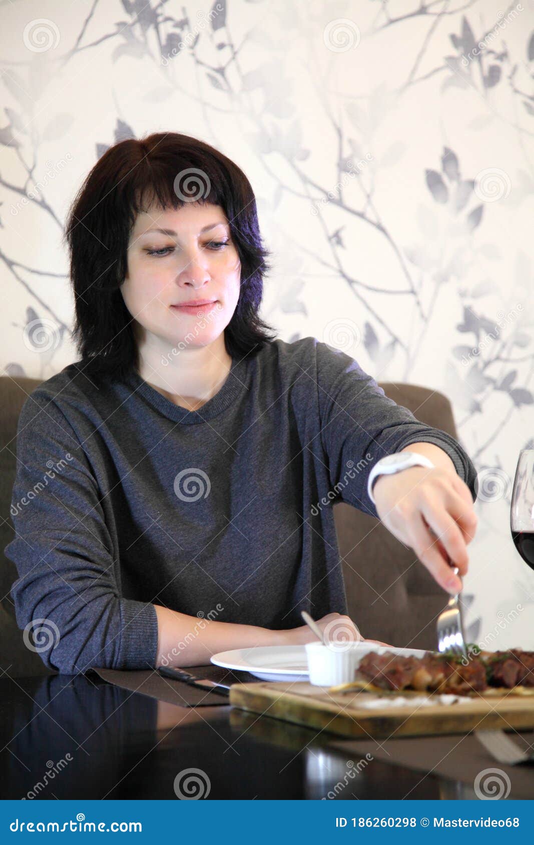 Girl Eats Steak with Wine. Girl Passionately Eats Steak Stock Photo ...