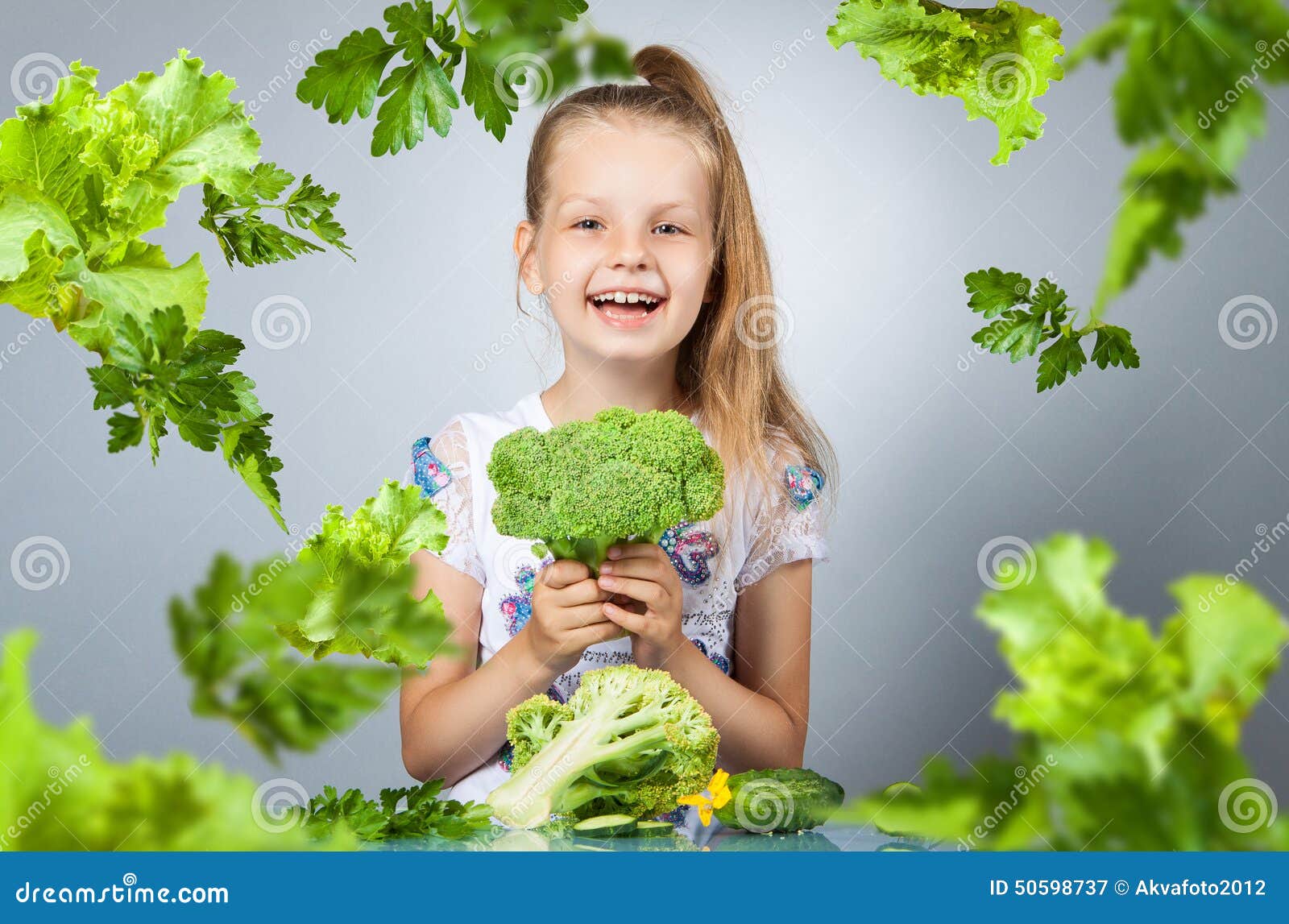 Girl eats vegetables stock image. Image of kids, green - 50598737