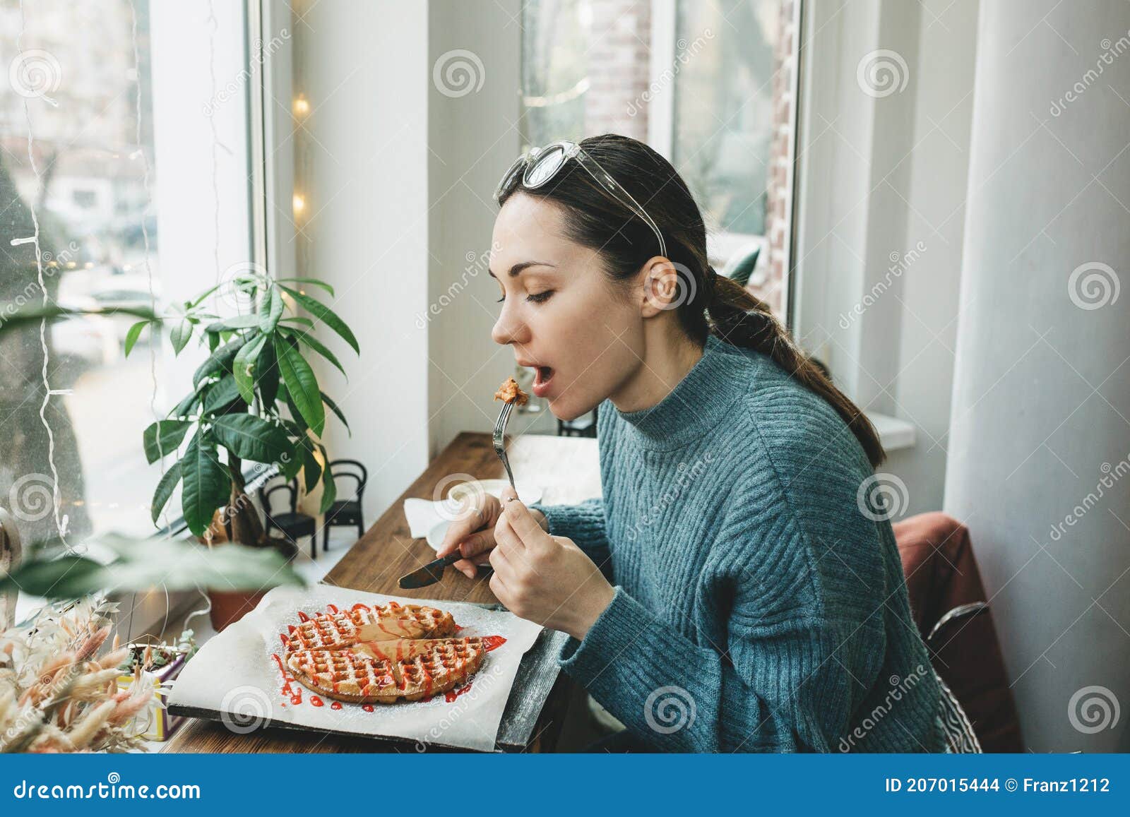 The girl eats a waffle stock photo. Image of gourmet - 207015444