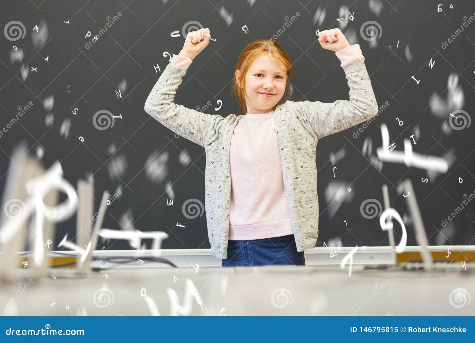 Girl in Elementary School Cheers in Front of Blackboard Stock Image ...