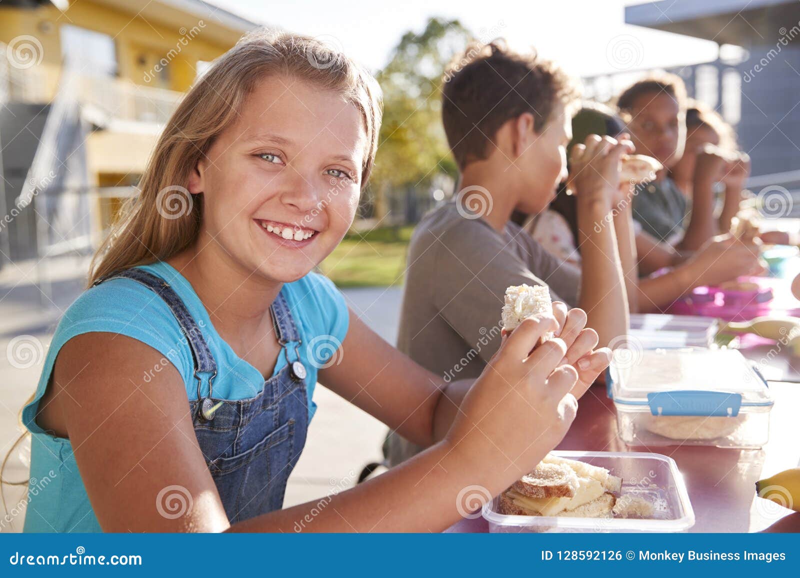 Girl At Elementary School Lunch Table Smiling To Camera Stock Photo ...