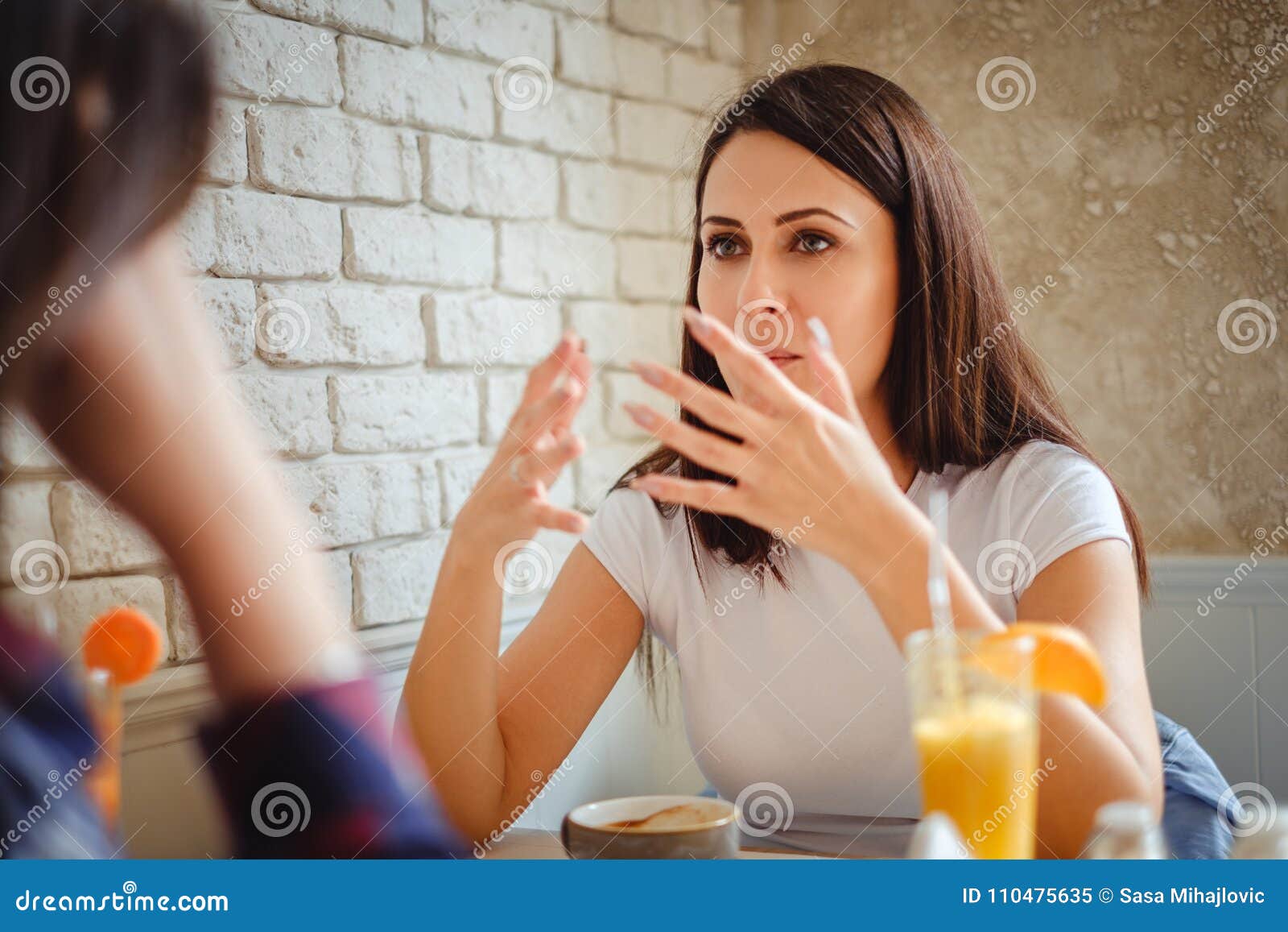 Girl Explaining Something To Her Friend in the Restaurant Stock Image ...