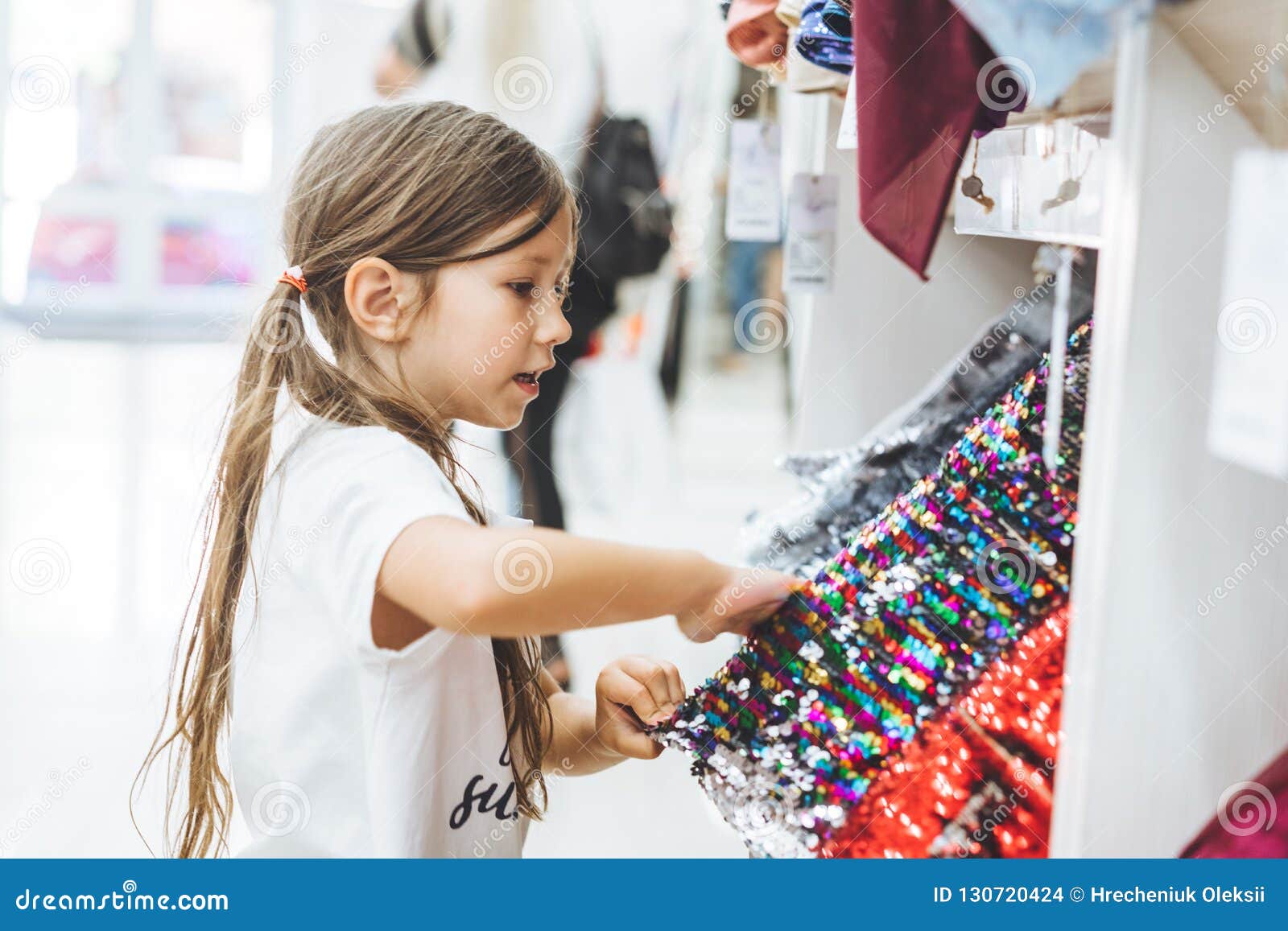 Girl in a Fabric Store Chooses a Multi-colored Fabric Stock Photo ...