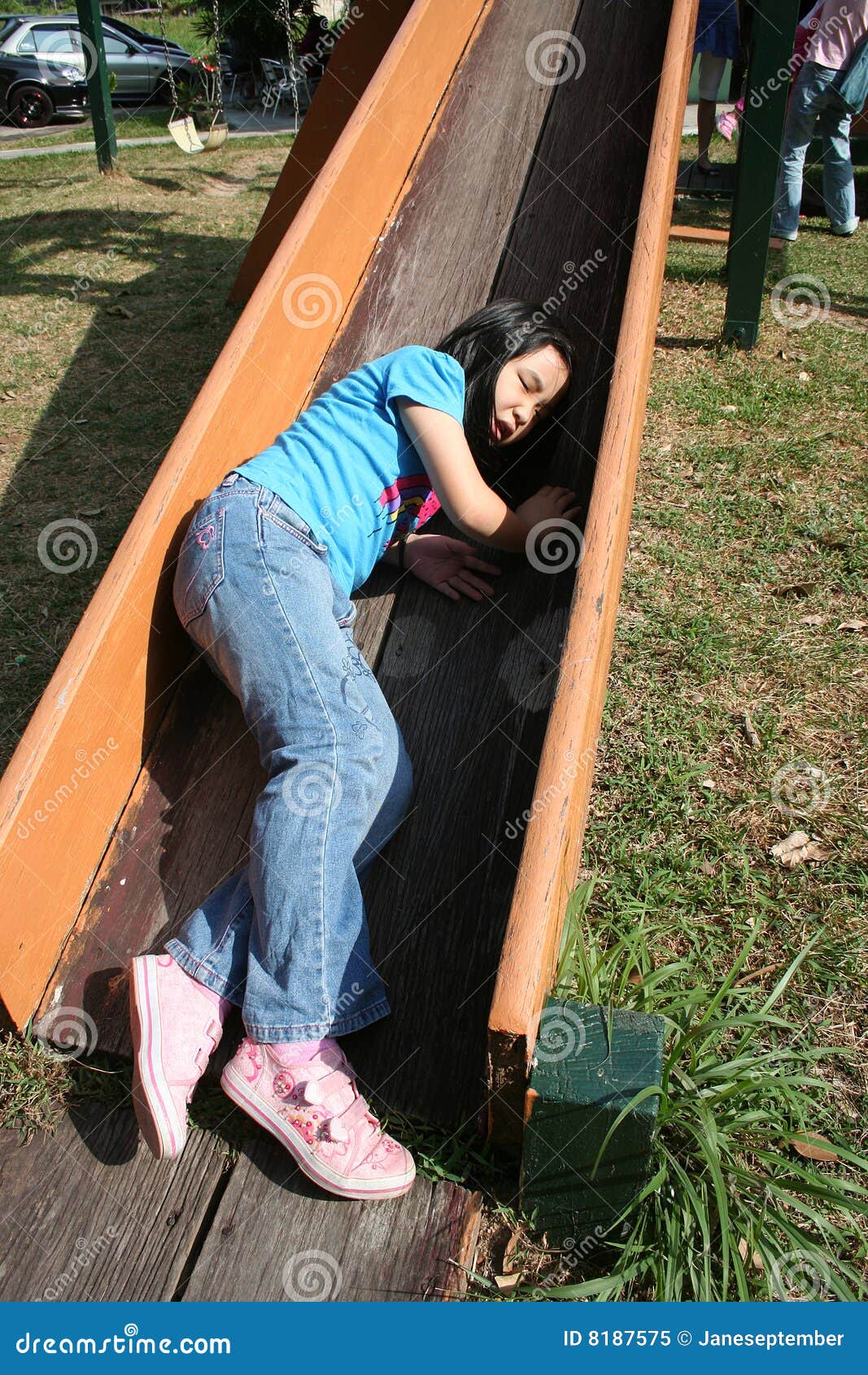Girl falling on the slide stock image. Image of jeans - 8187575