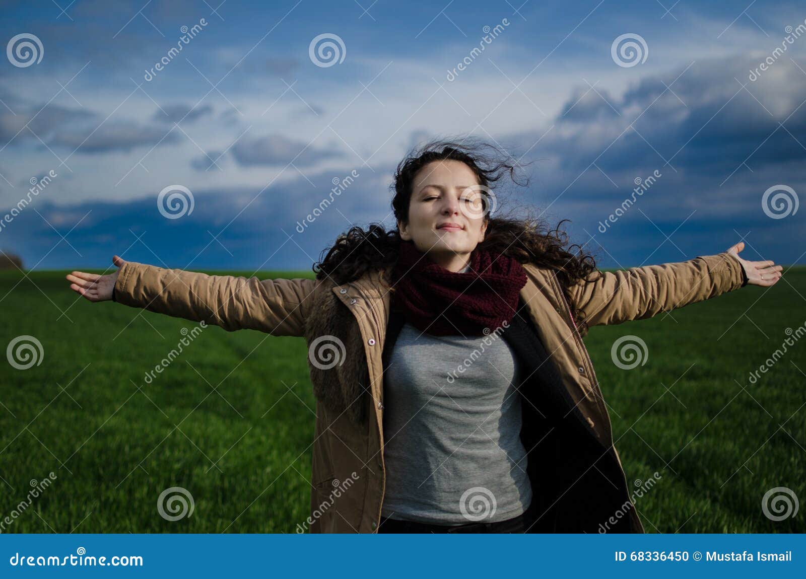 A Girl Feeling Joy and Happy in the Green Field with Clouds Stock Photo ...