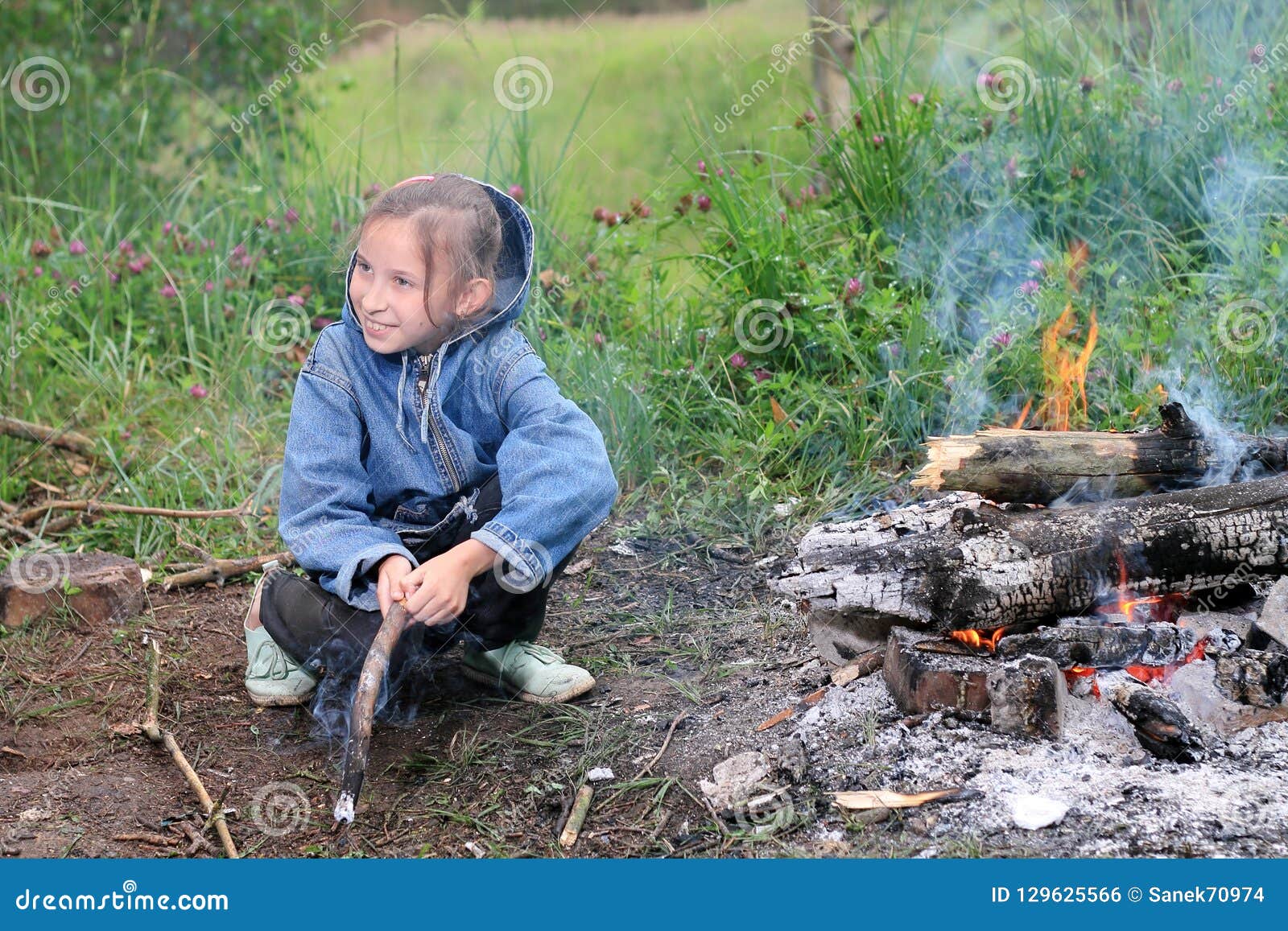 Girl by the fire stock photo. Image of portrait, nature - 129625566