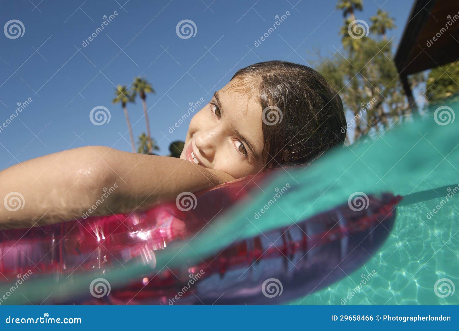 Girl Floating On Inflatable Raft In Swimming Pool Royalty-Free Stock ...