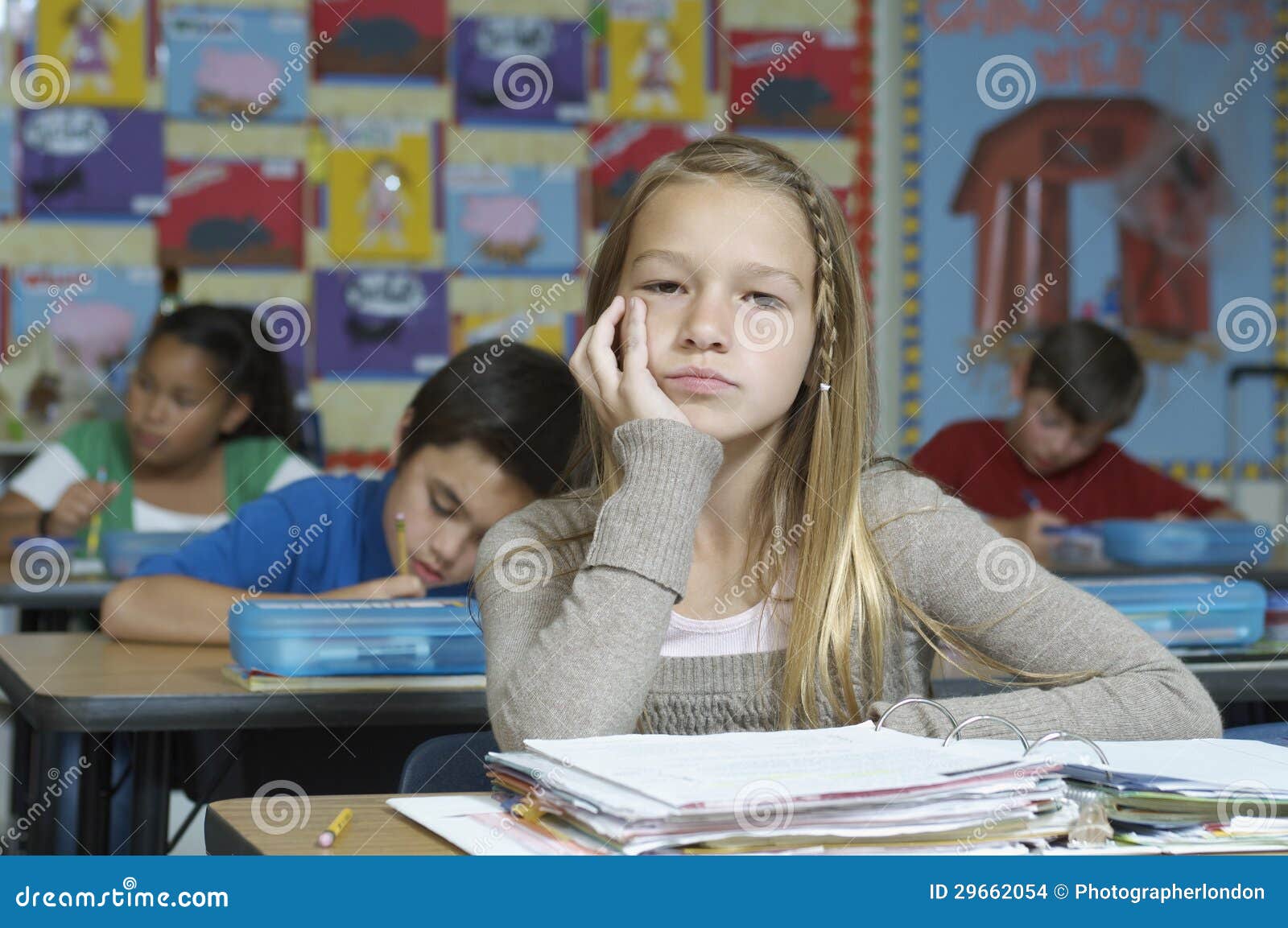 Girl Getting Bored while Classmates Writing Notes in the Background ...