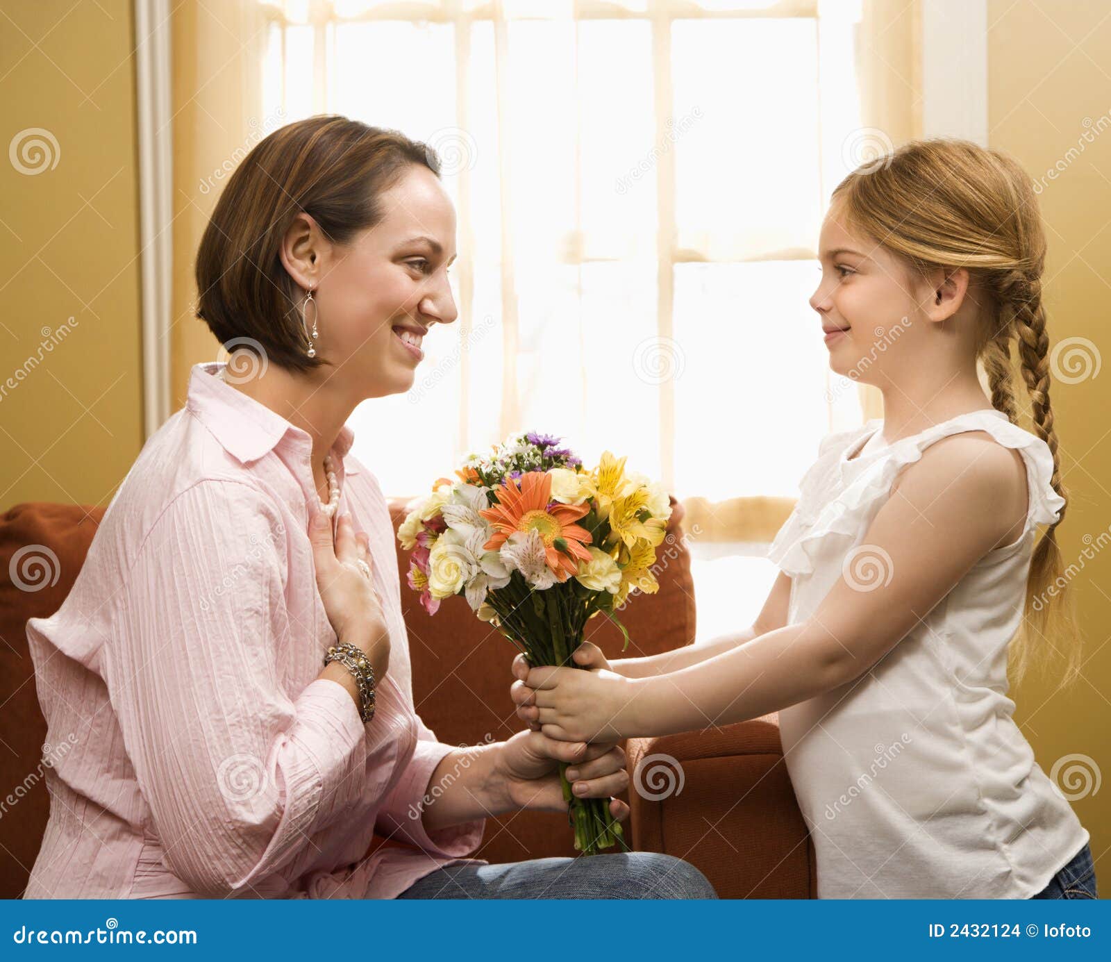 Girl giving mom flowers. stock photo. Image of bouquet - 2432124