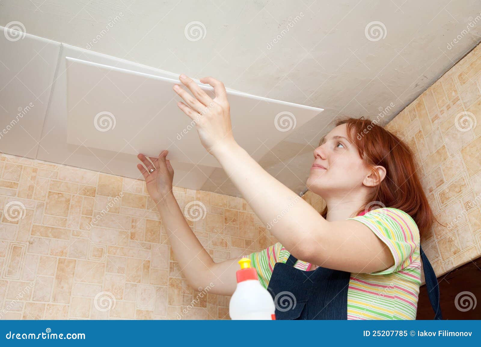 Girl glues ceiling tile stock image. Image of handyman - 25207785