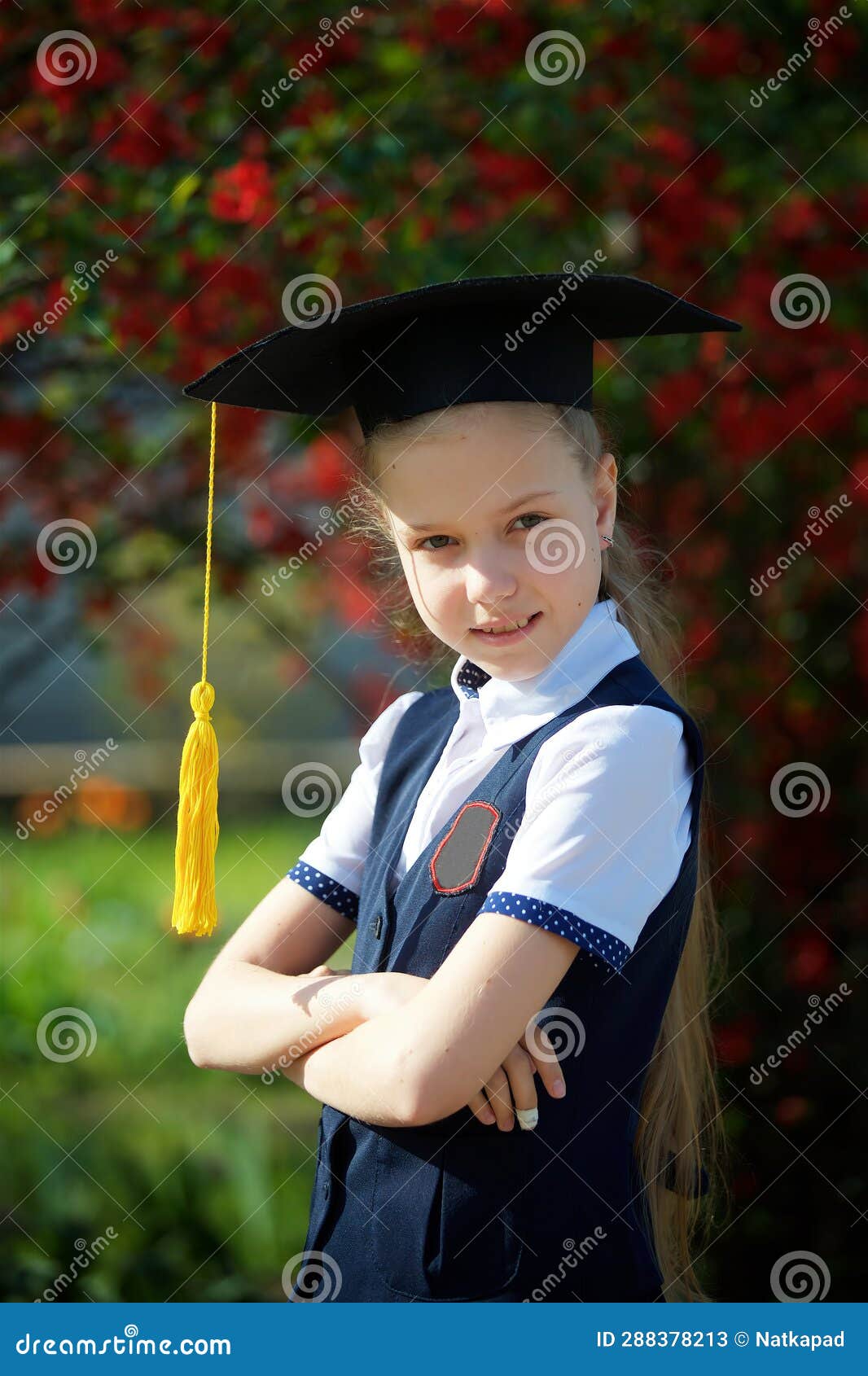 A Girl is a Graduate of an Elementary School in a Graduate Hat Stock ...