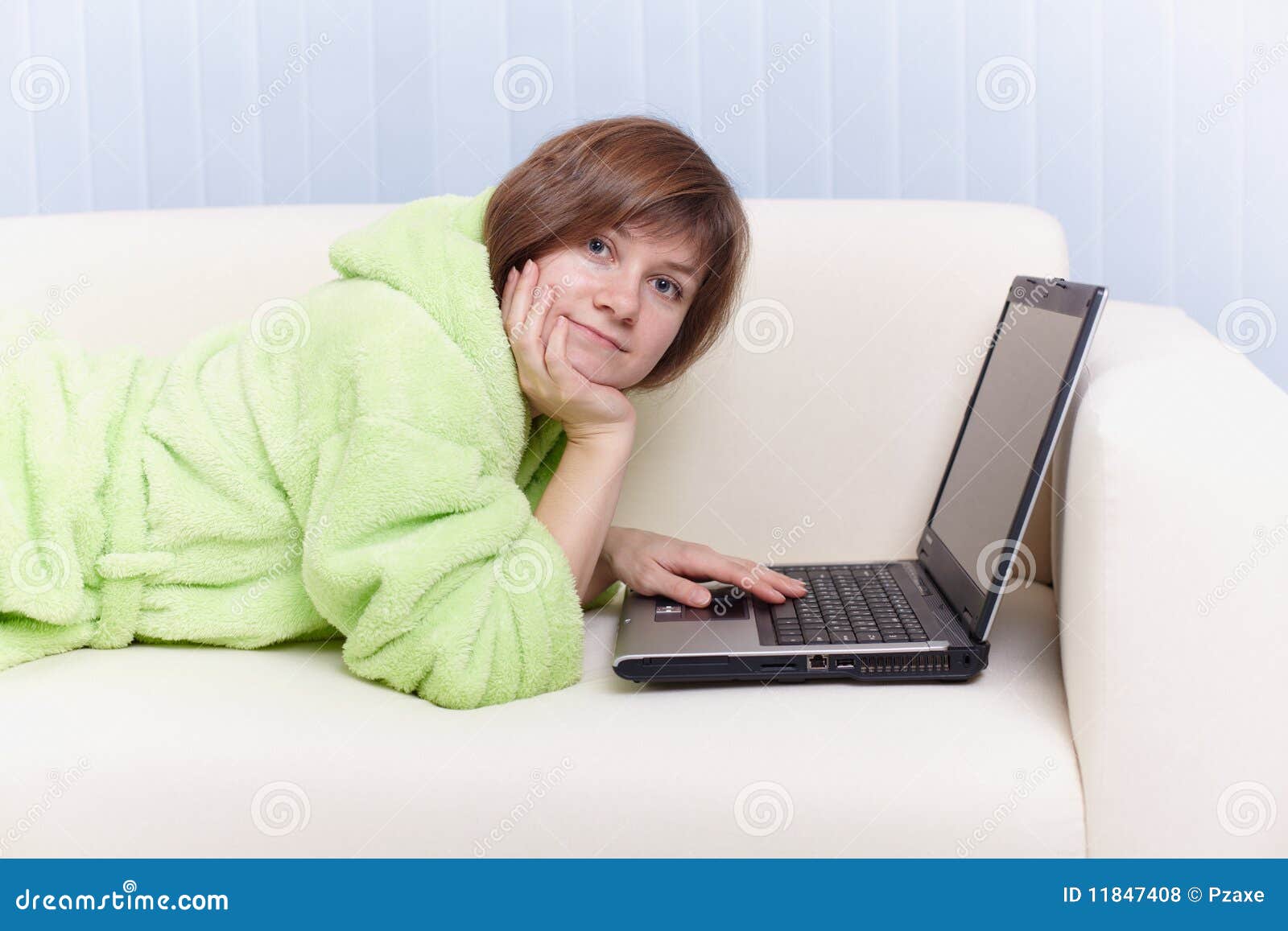Girl in Green Dressing Gown on Sofa with Computer Stock Photo - Image ...