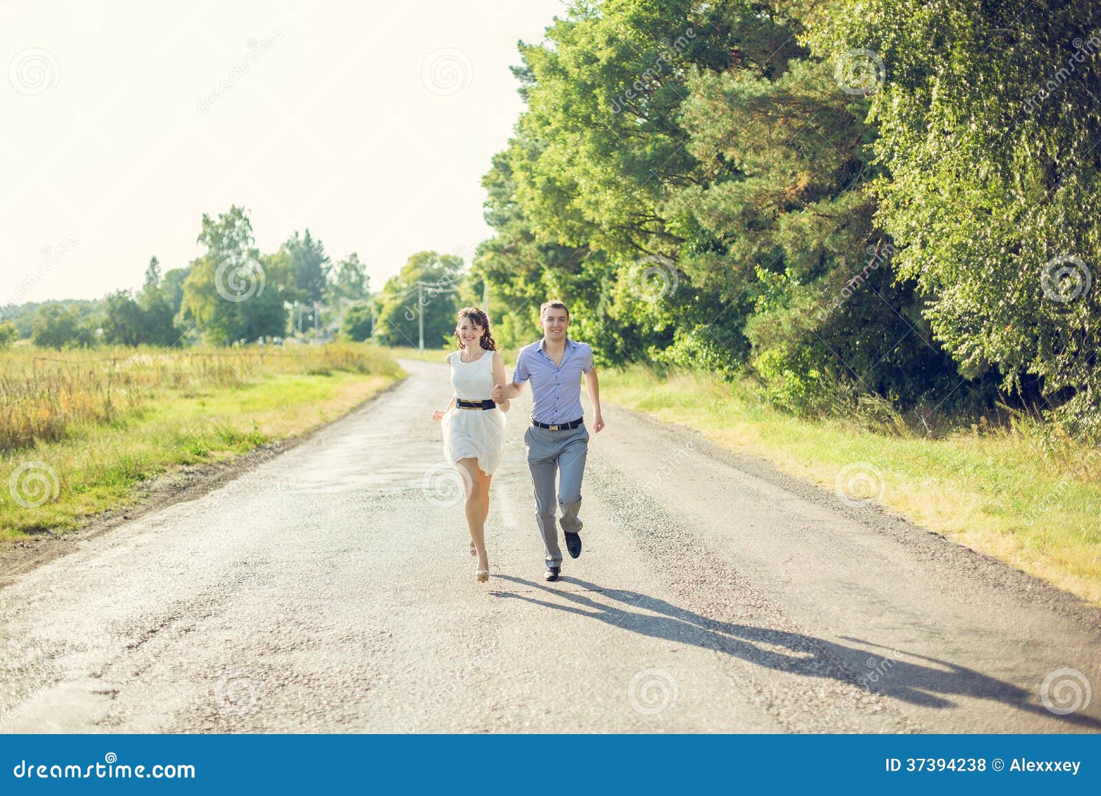Girl with a Guy Running Down the Road Stock Photo - Image of european ...