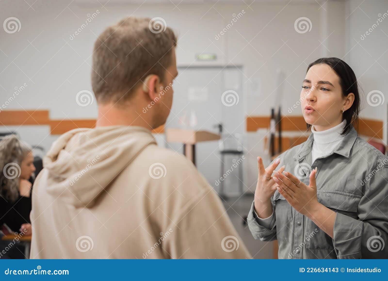 The Girl and the Guy Talk in Sign Language. Two Deaf Students Chatting ...