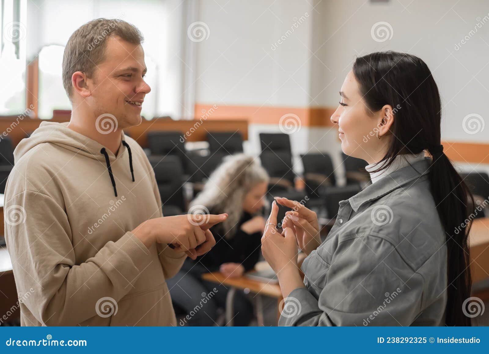 The Girl and the Guy Talk in Sign Language. Two Deaf Students Chatting ...