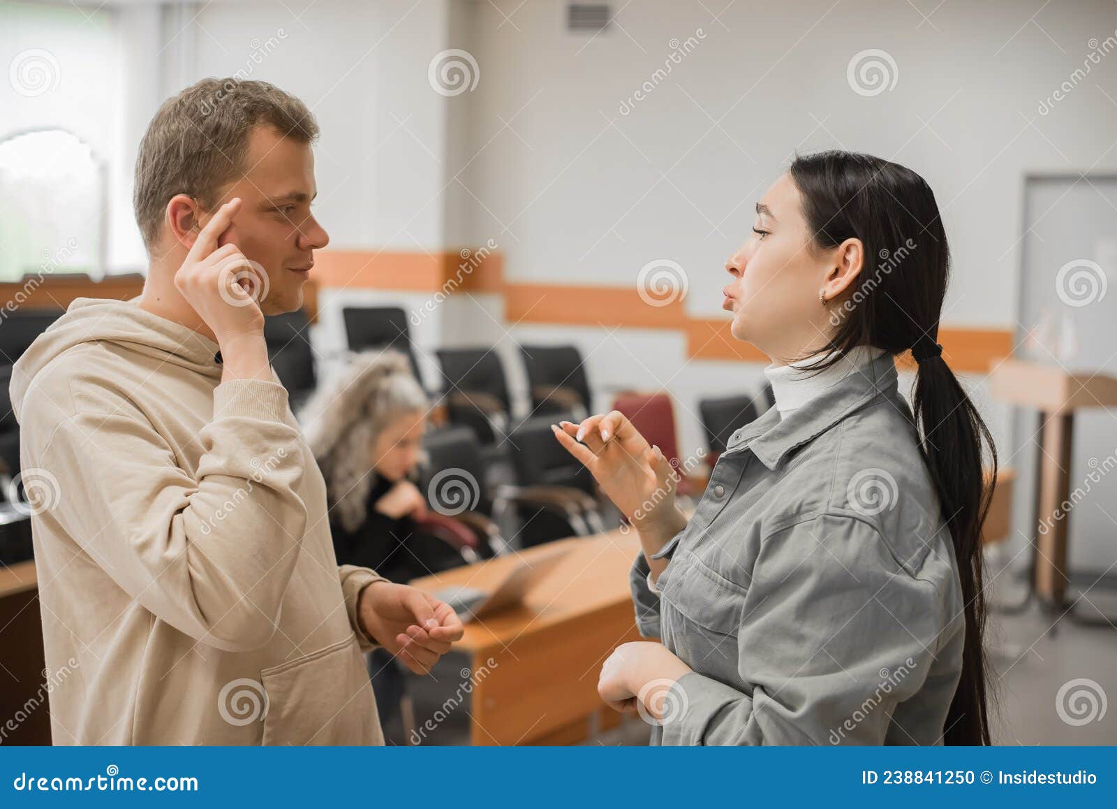 The Girl and the Guy Talk in Sign Language. Two Deaf Students Chatting ...