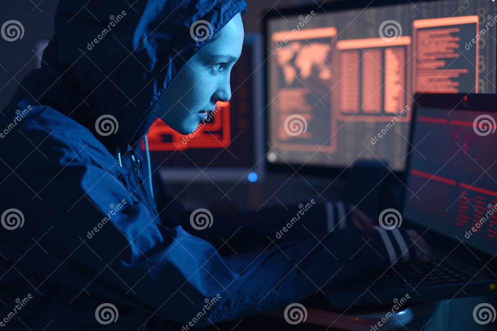 Girl Hacker in a Hood Typing Program Code while Committing a Cybercrime ...