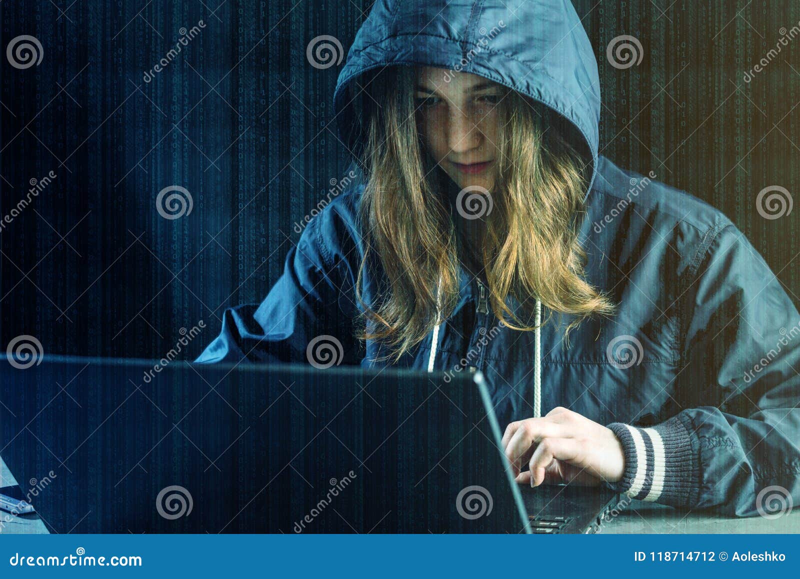 Girl Hacker In A Hood Typing Program Code While Committing A Cybercrime