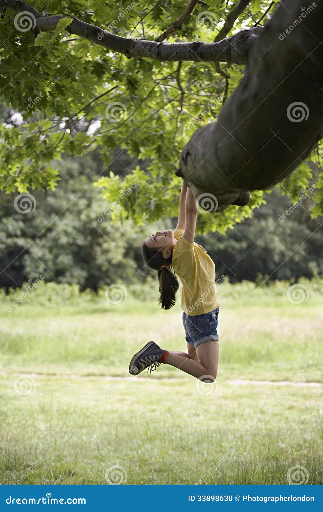 Girl Hanging from Tree Branch Stock Photo - Image of holding, happy ...